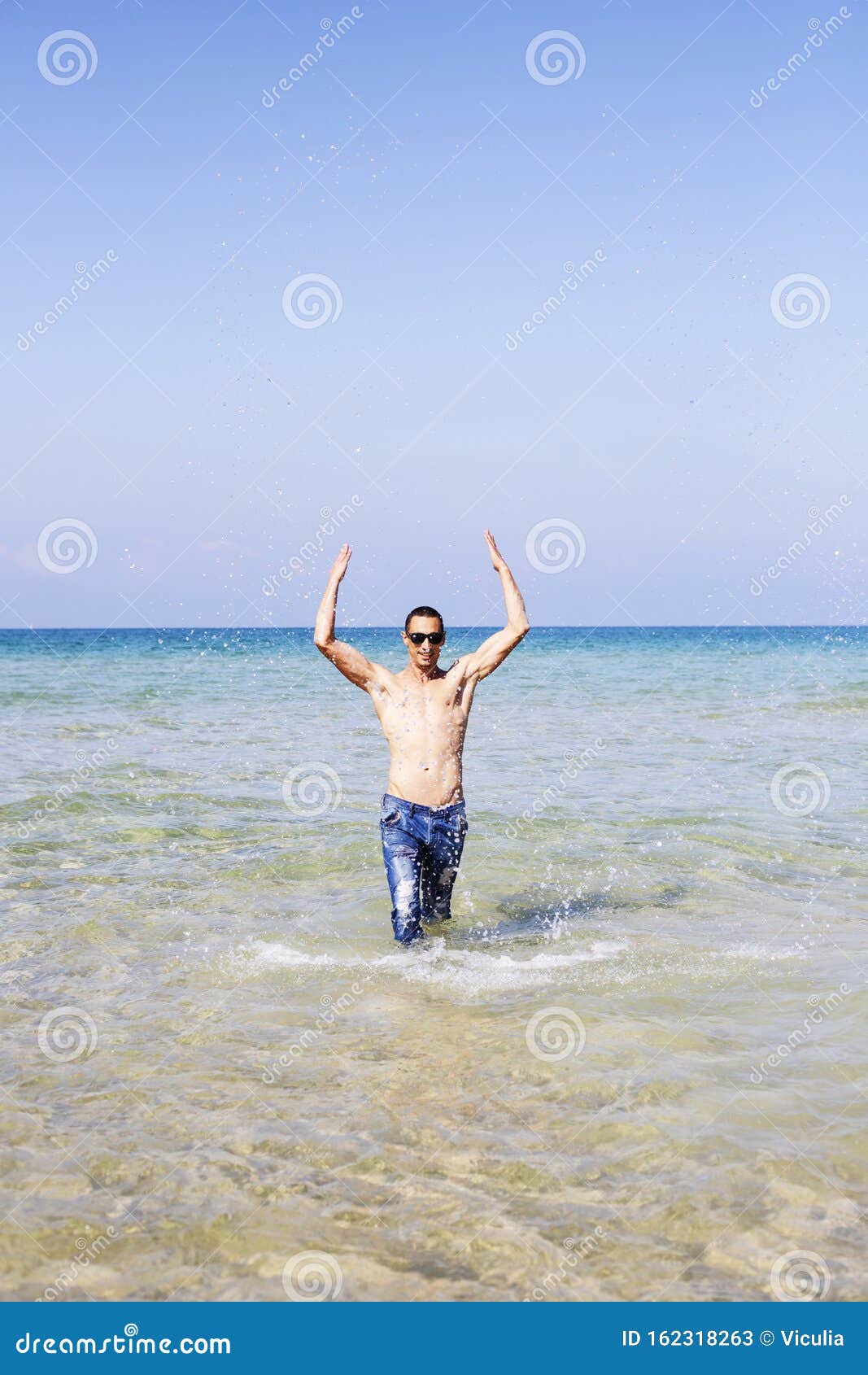 Young Muscular Man Posing and Splashing Around in the Sea Stock Image ...