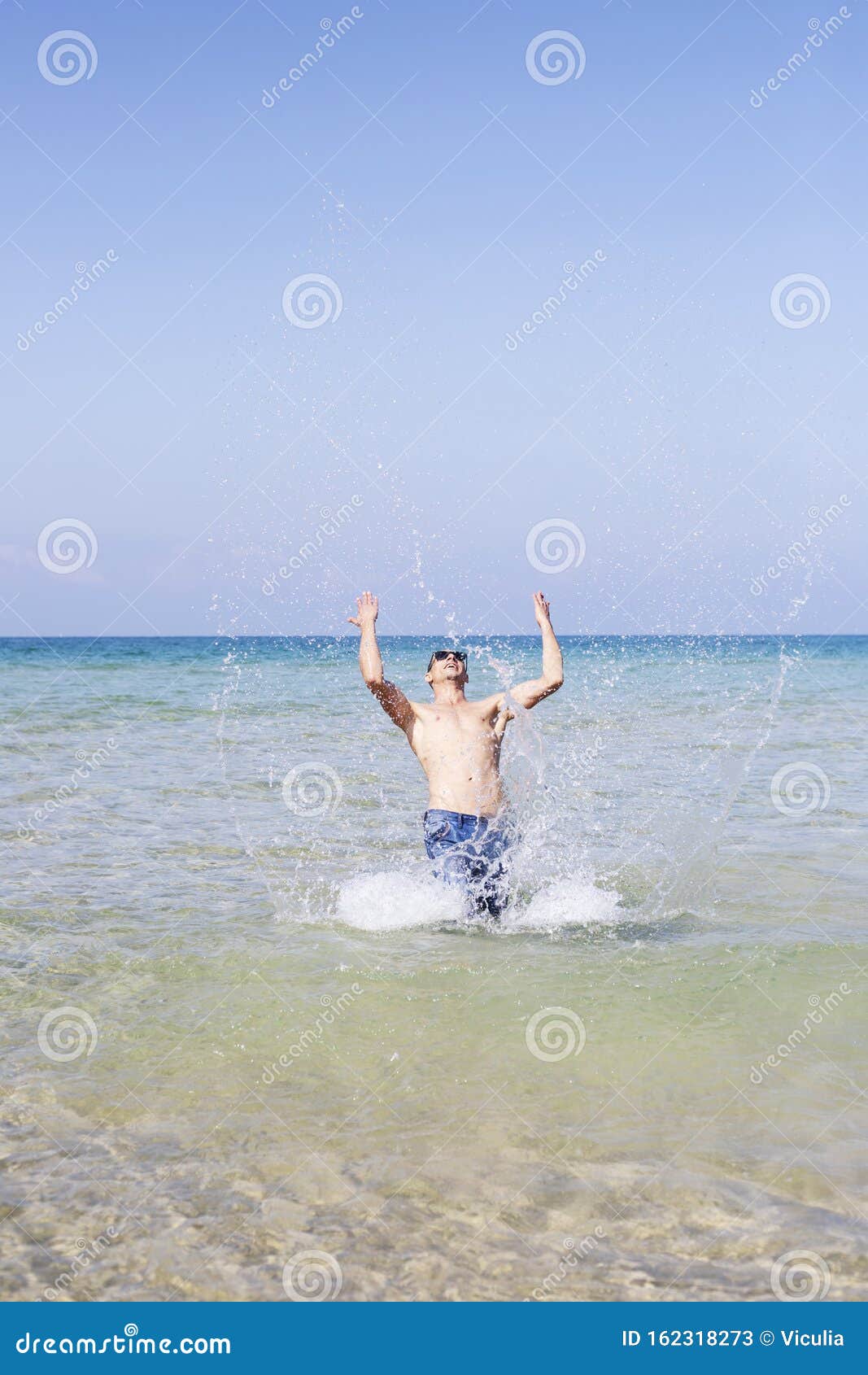 Young Muscular Man Posing and Splashing Around in the Sea Stock Image ...