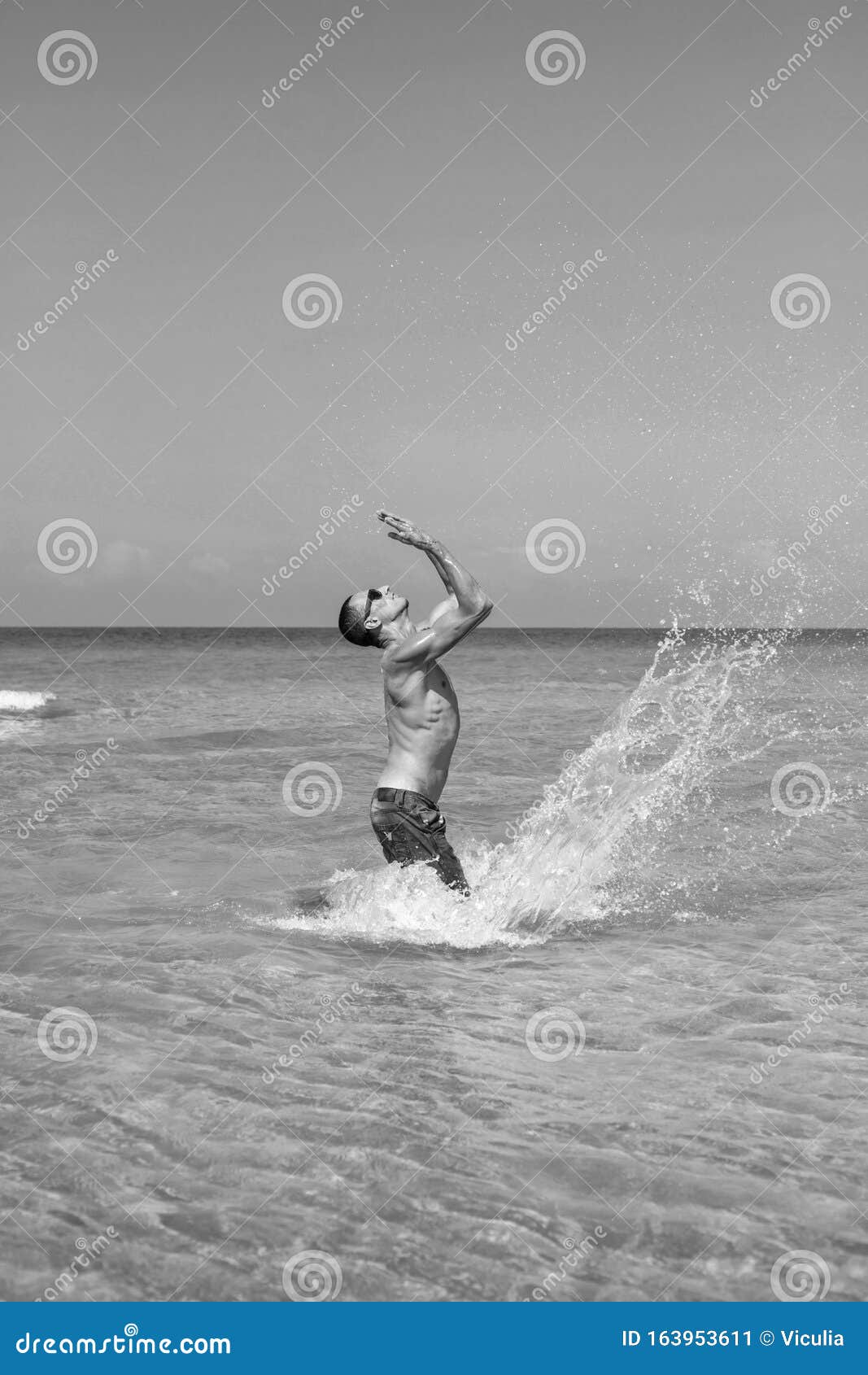 Young Muscular Man Posing and Splashing Around in the Sea Stock Image ...