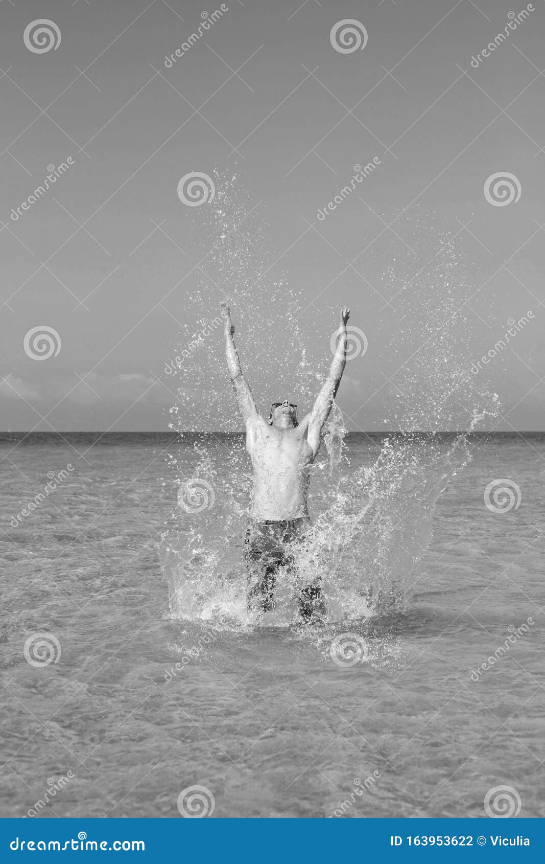 Young Muscular Man Posing and Splashing Around in the Sea Stock Photo ...