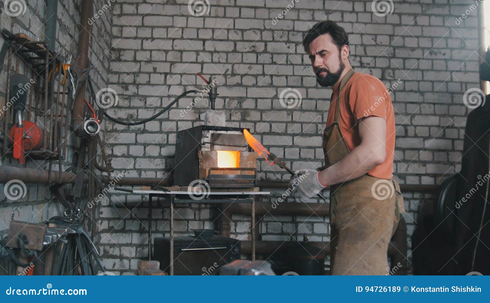 Young Muscular Man Working on a Blacksmith with Metal Stock Image ...