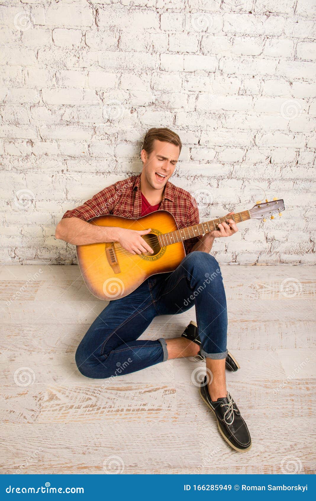 Young Musician Siting on Floor with Guitar and Singing Stock Image ...