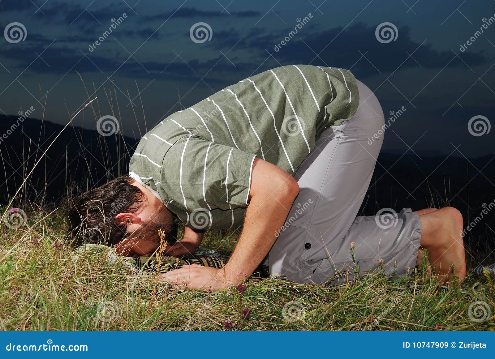 Young Muslim Man is Praying on Meadow Sunset Time Stock Image - Image ...