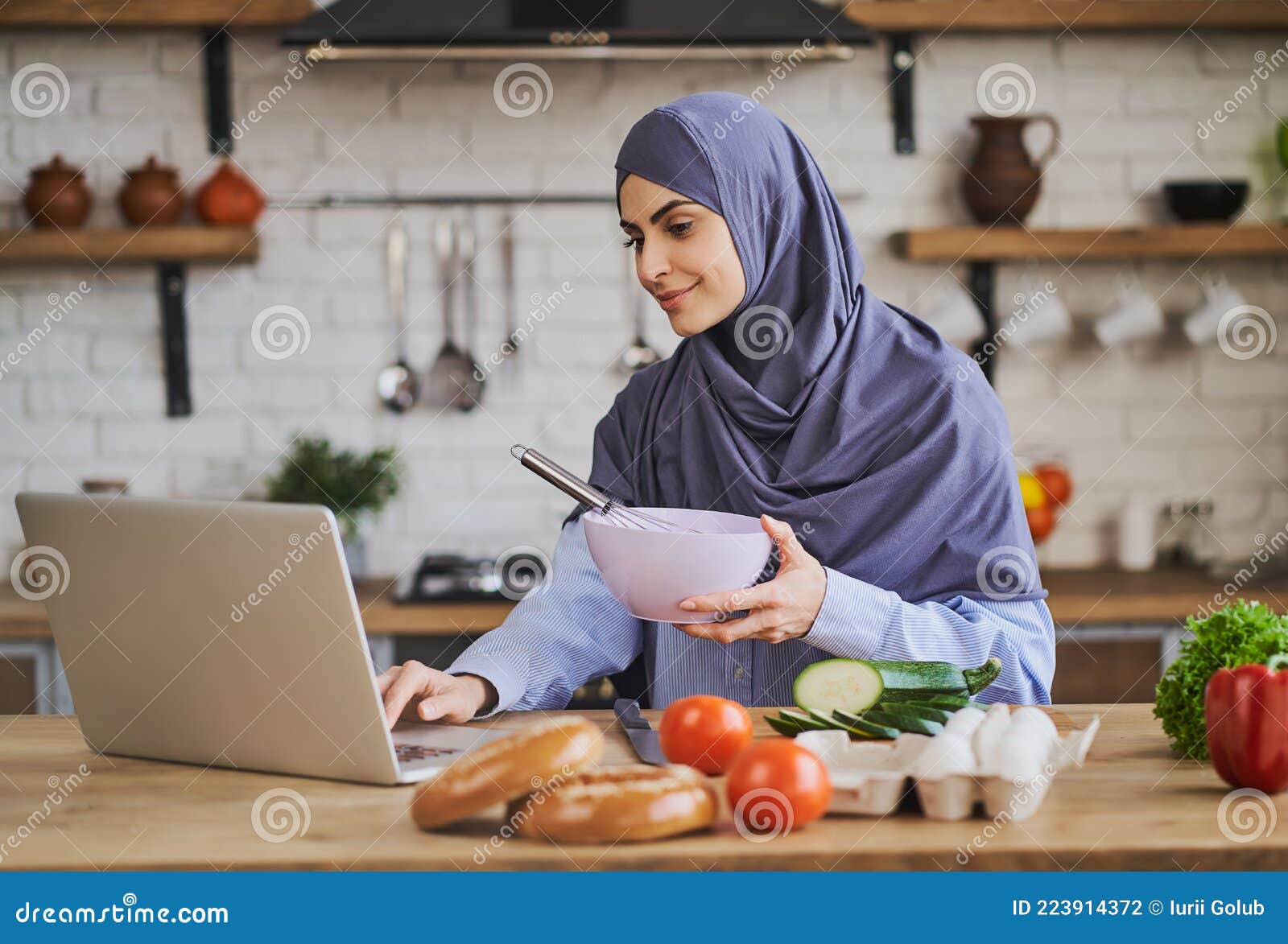 Young Muslim Woman Watching a Culinary Tutorial and Cooking Stock Photo ...