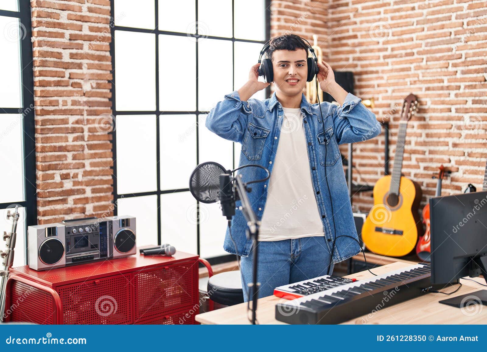 Young Non Binary Man Artist Listening To Music at Music Studio Stock ...