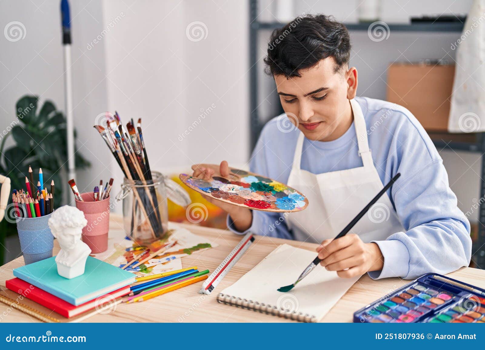 Young Non Binary Man Artist Smiling Confident Drawing on Notebook at ...