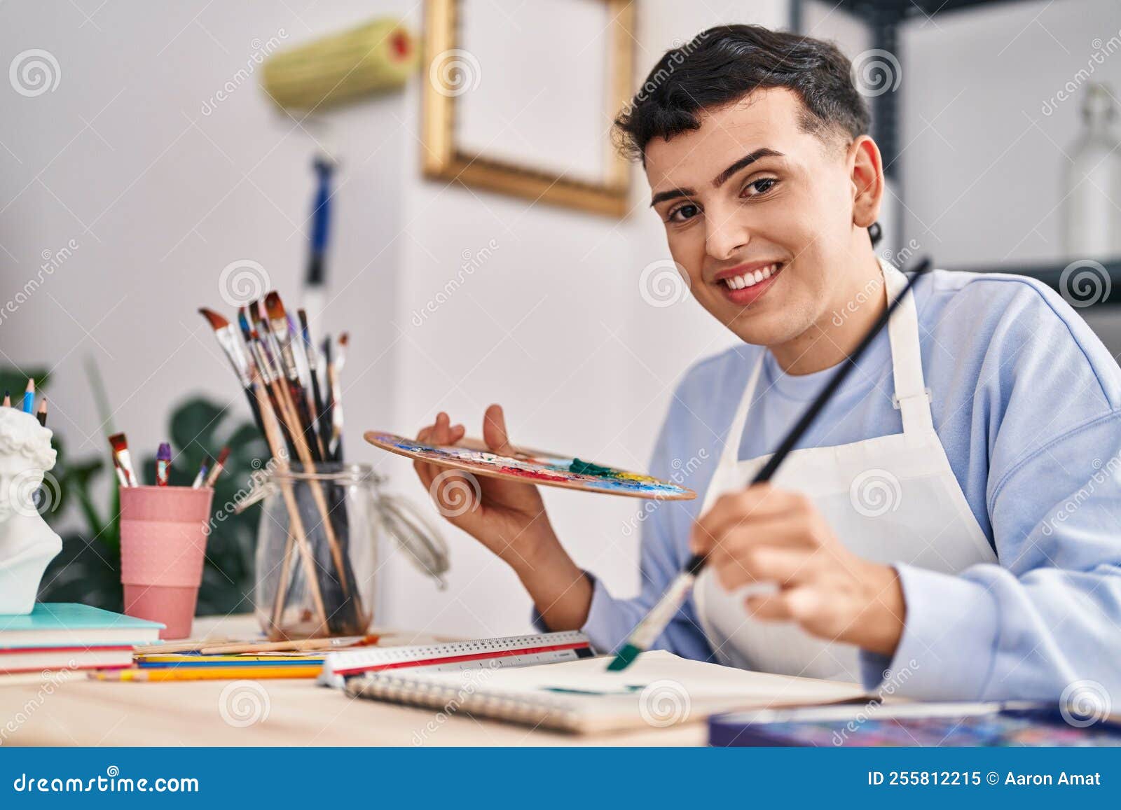 Young Non Binary Man Artist Smiling Confident Drawing on Notebook at ...