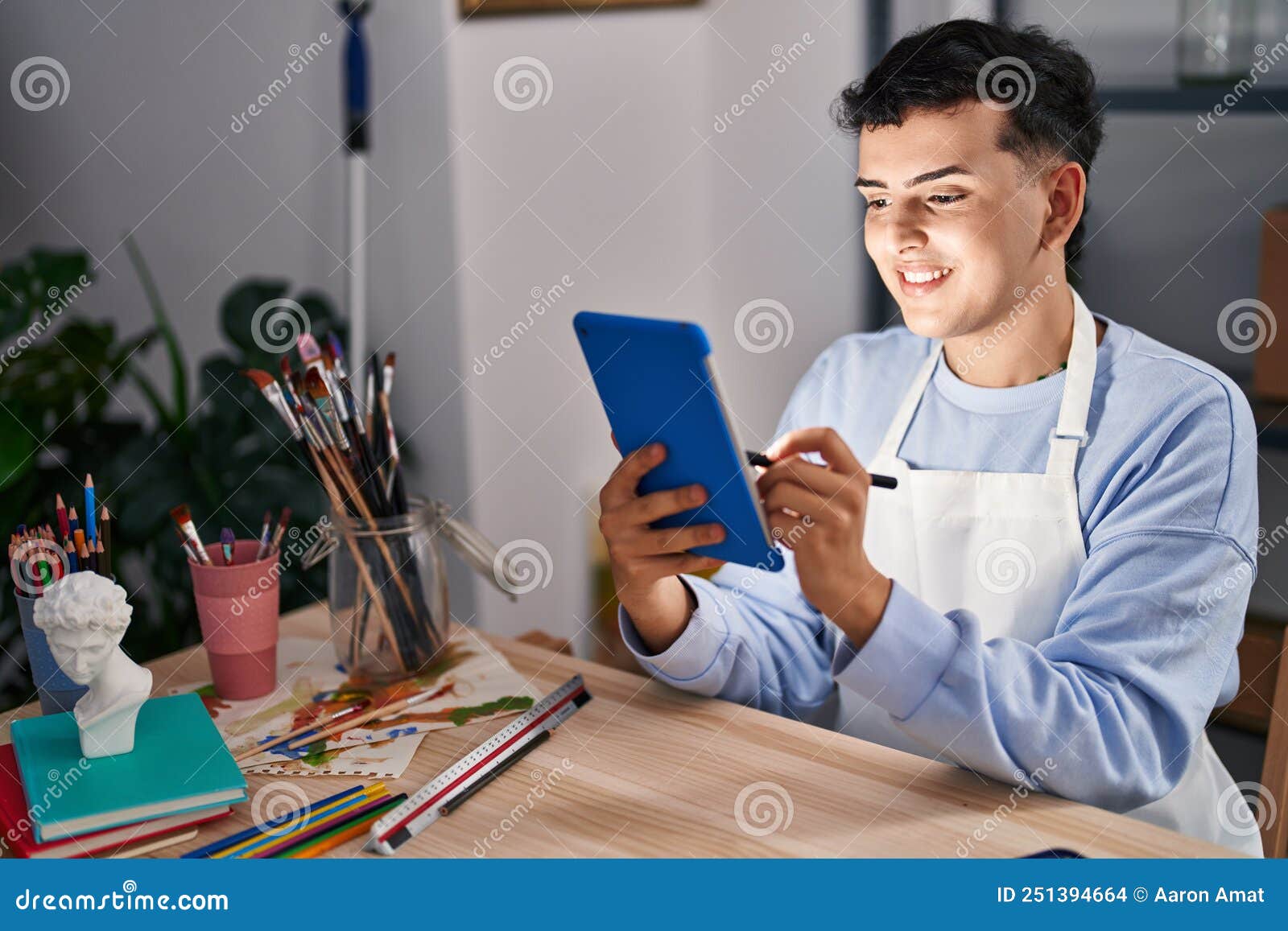 Young Non Binary Man Artist Smiling Confident Drawing on Touchpad at ...