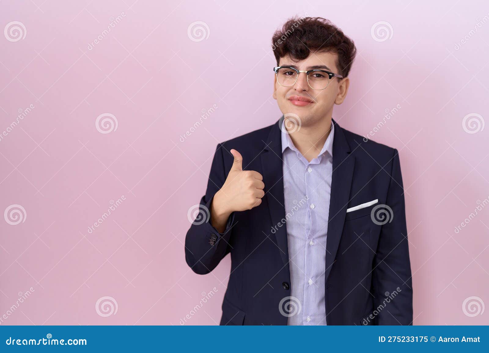 Young Non Binary Man with Beard Wearing Suit and Tie Doing Happy Thumbs ...