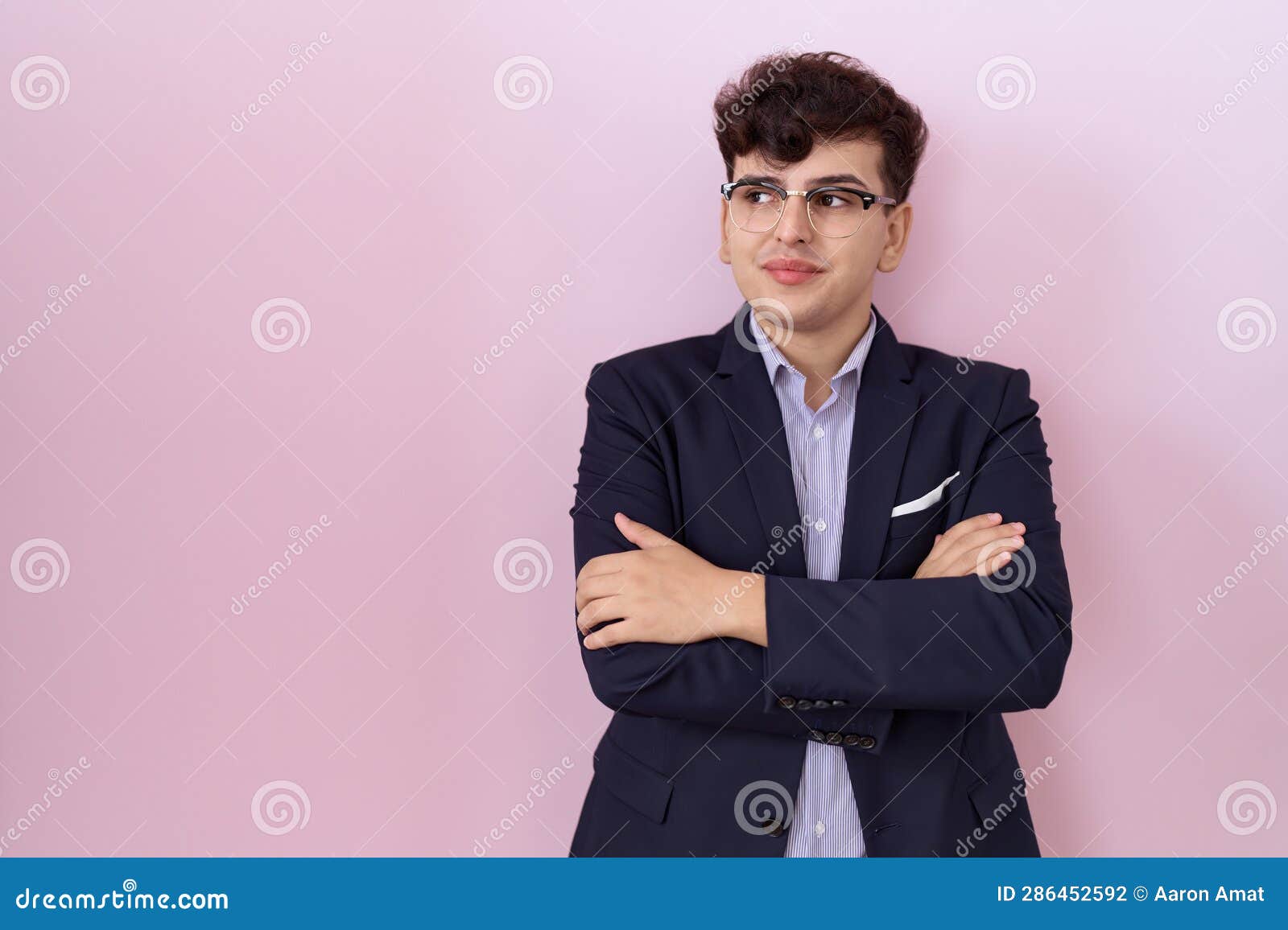 Young Non Binary Man with Beard Wearing Suit and Tie Smiling Looking To the Side and Staring ...
