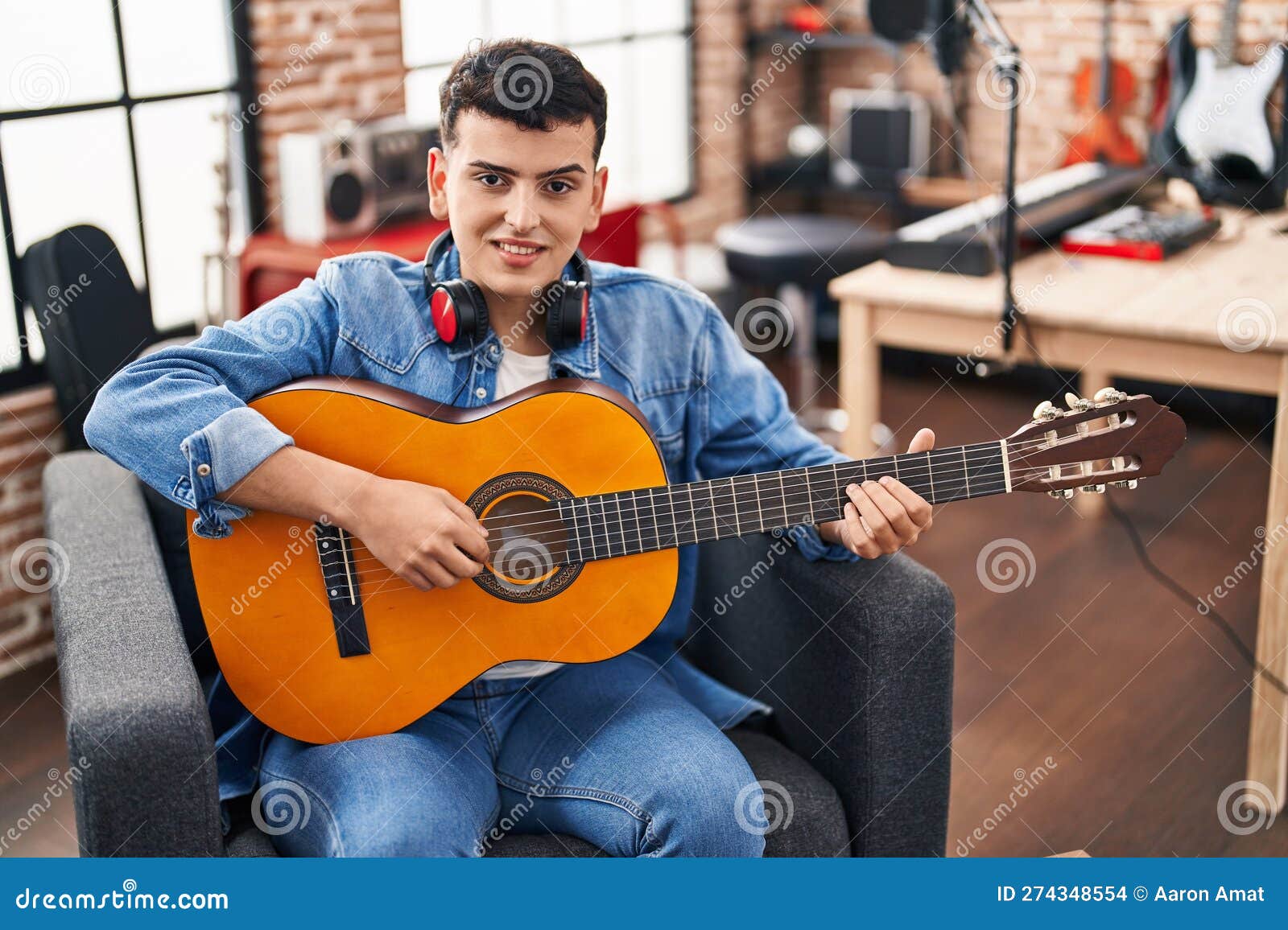 Young Non Binary Man Musician Playing Classical Guitar at Music Studio ...