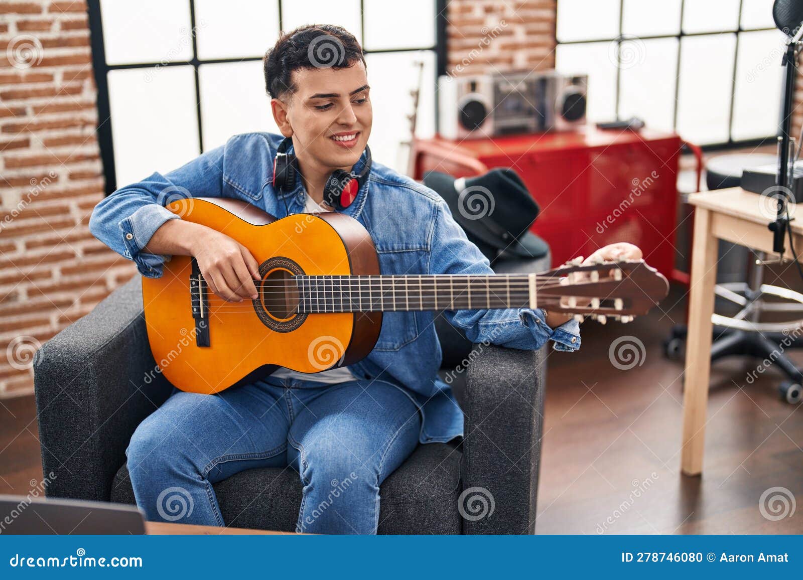 Young Non Binary Man Musician Playing Classical Guitar at Music Studio ...