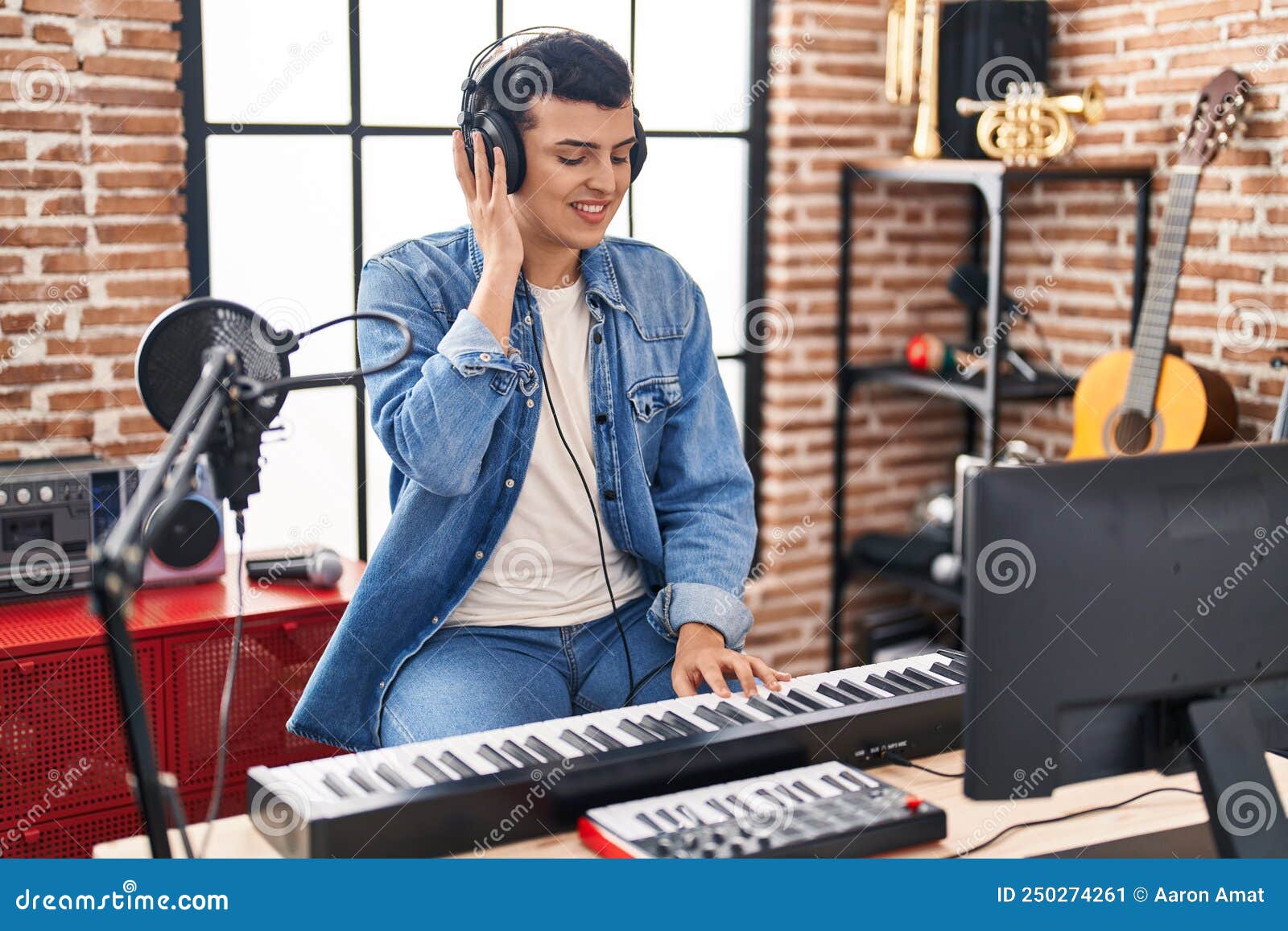 Young Non Binary Man Musician Playing Piano Keyboard at Music Studio ...