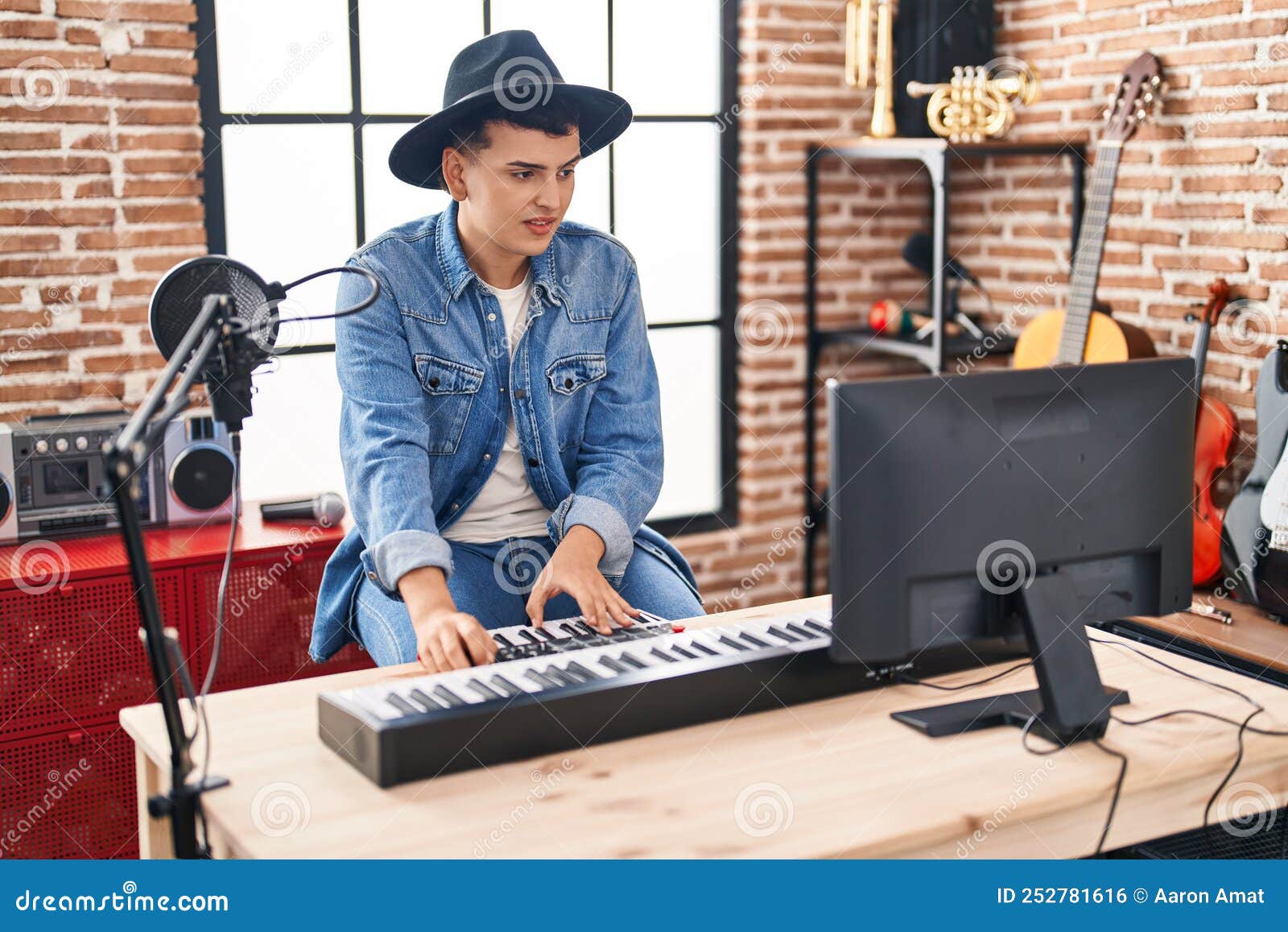 Young Non Binary Man Musician Playing Piano Keyboard at Music Studio ...