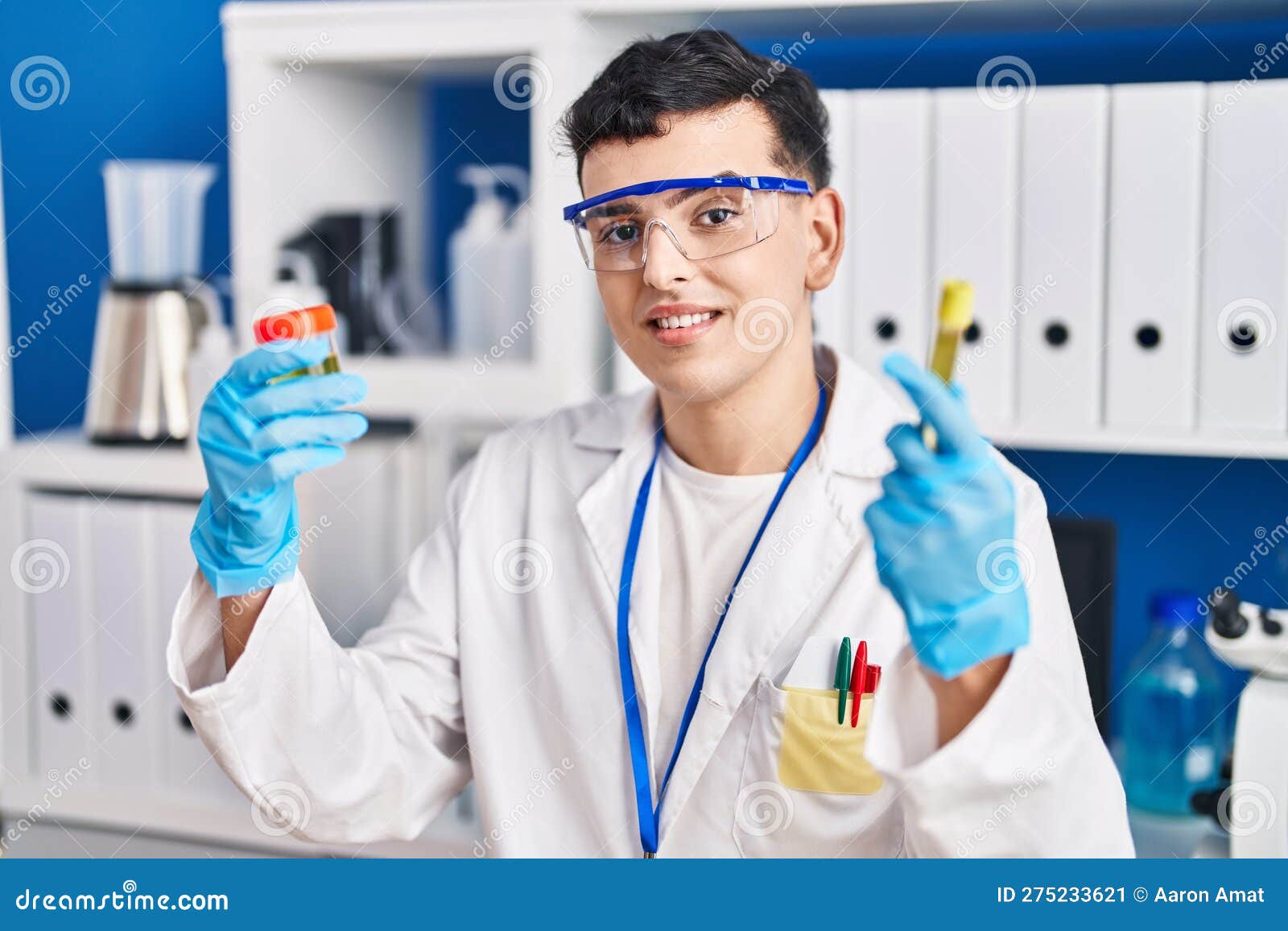 Young Non Binary Man Scientist Holding Urine Test Tubes at Laboratory ...