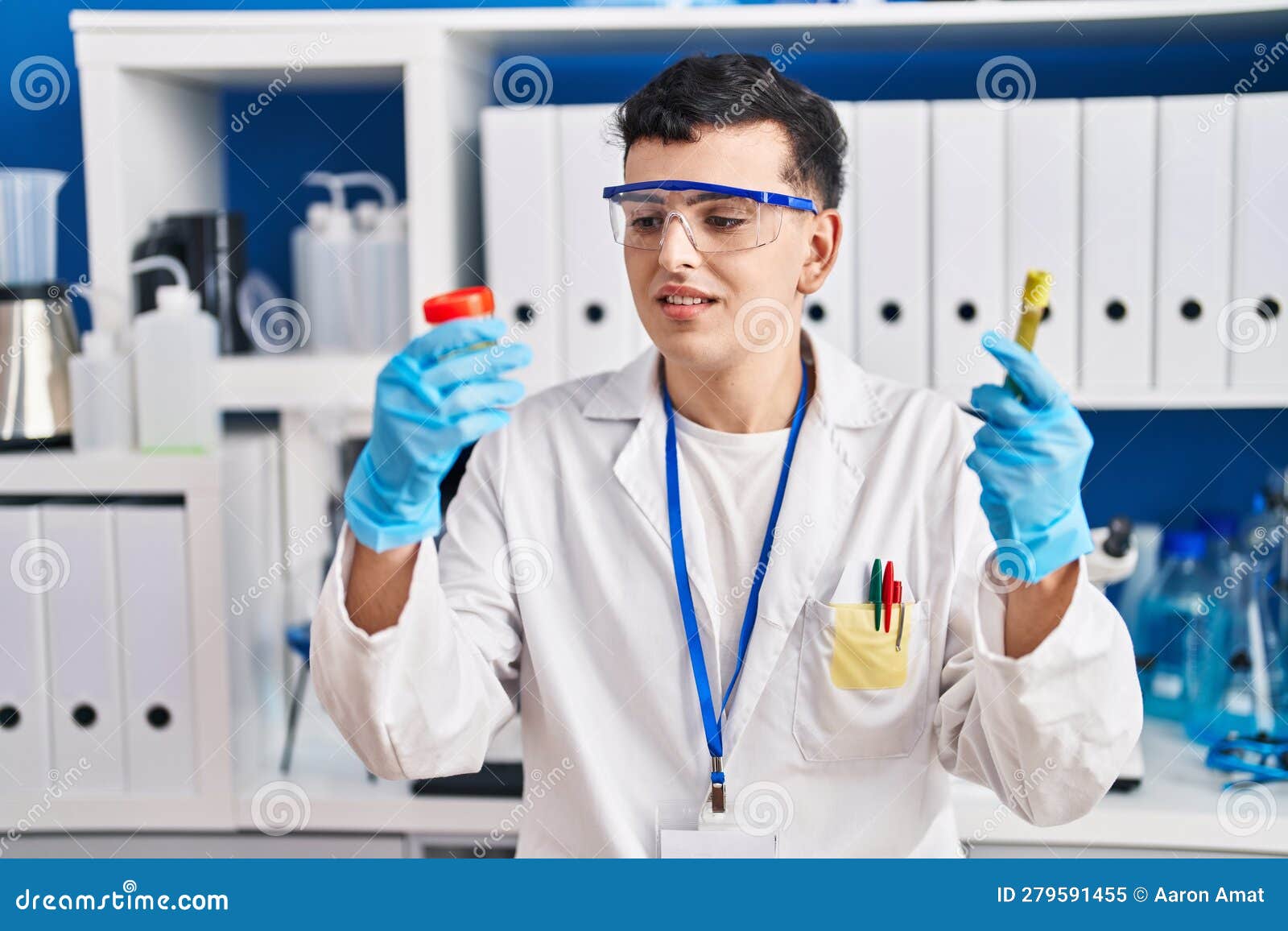 Young Non Binary Man Scientist Holding Urine Test Tubes at Laboratory ...