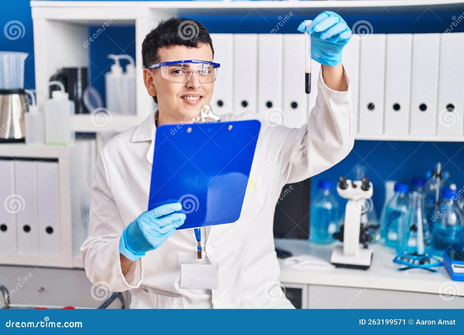 Young Non Binary Man Scientist Reading Report Holding Blood Test Tube ...