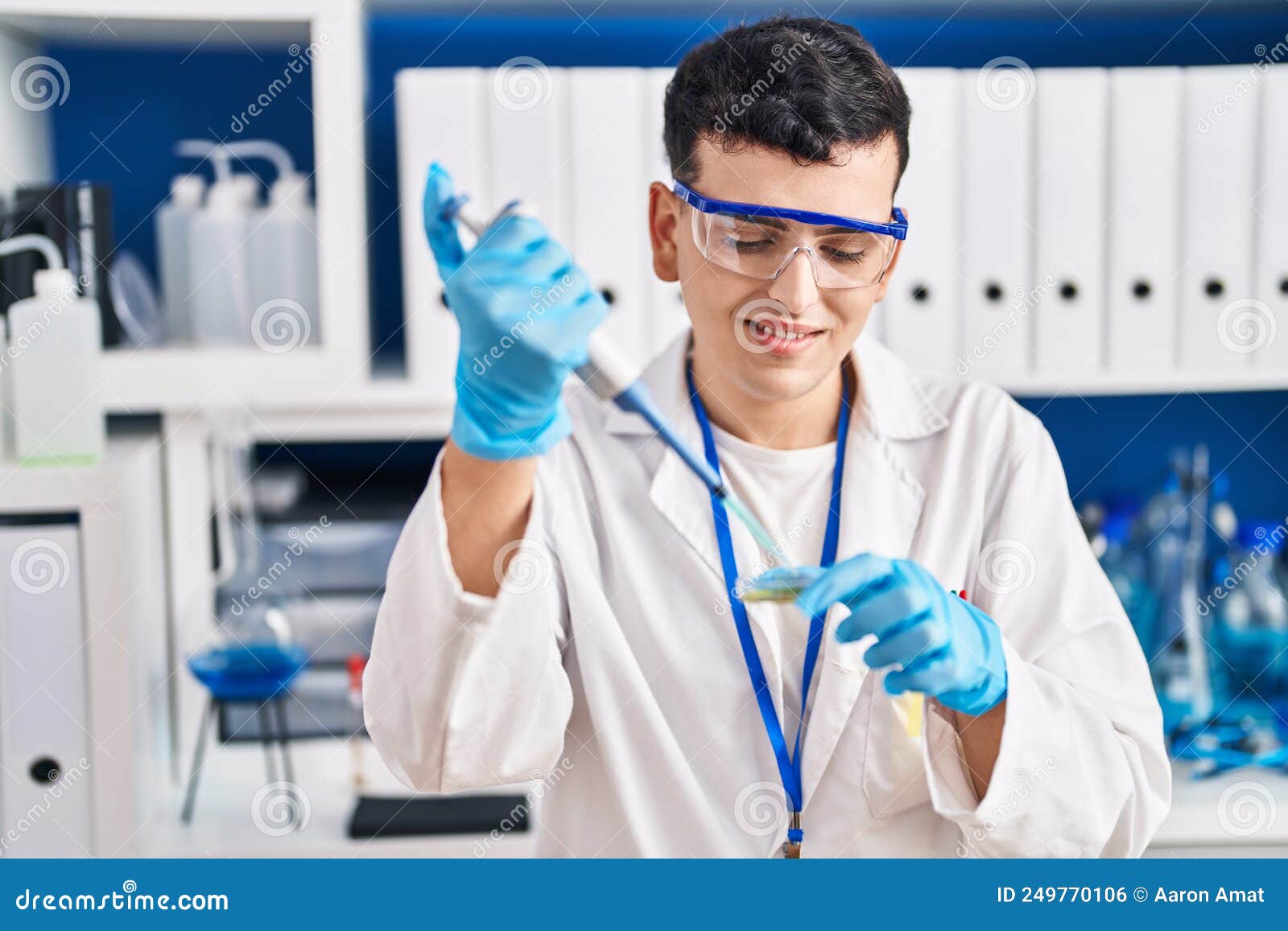 Young Non Binary Man Scientist Smiling Confident Using Pipette at ...