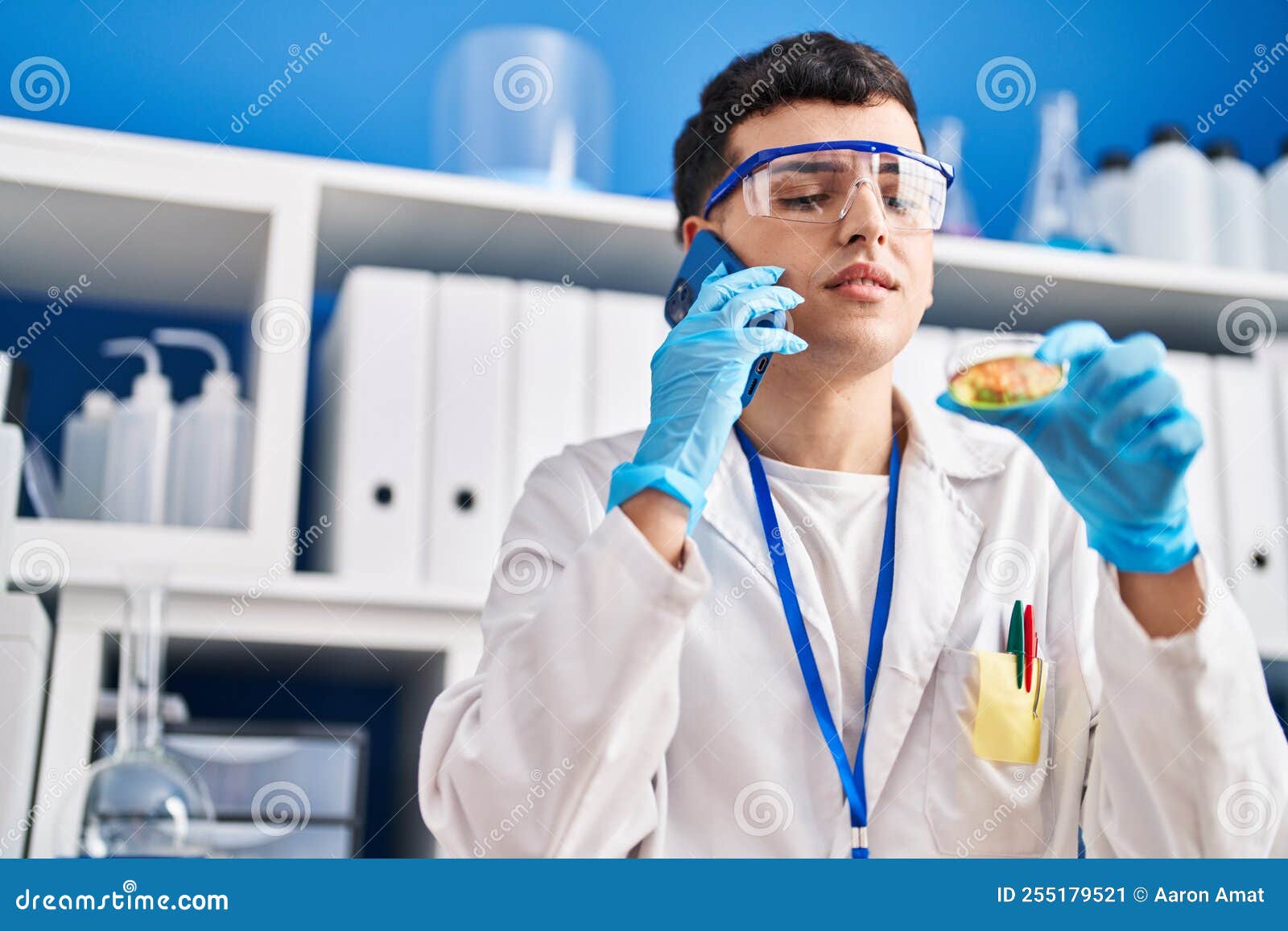 Young Non Binary Man Scientist Talking on the Smartphone Holding Sample ...