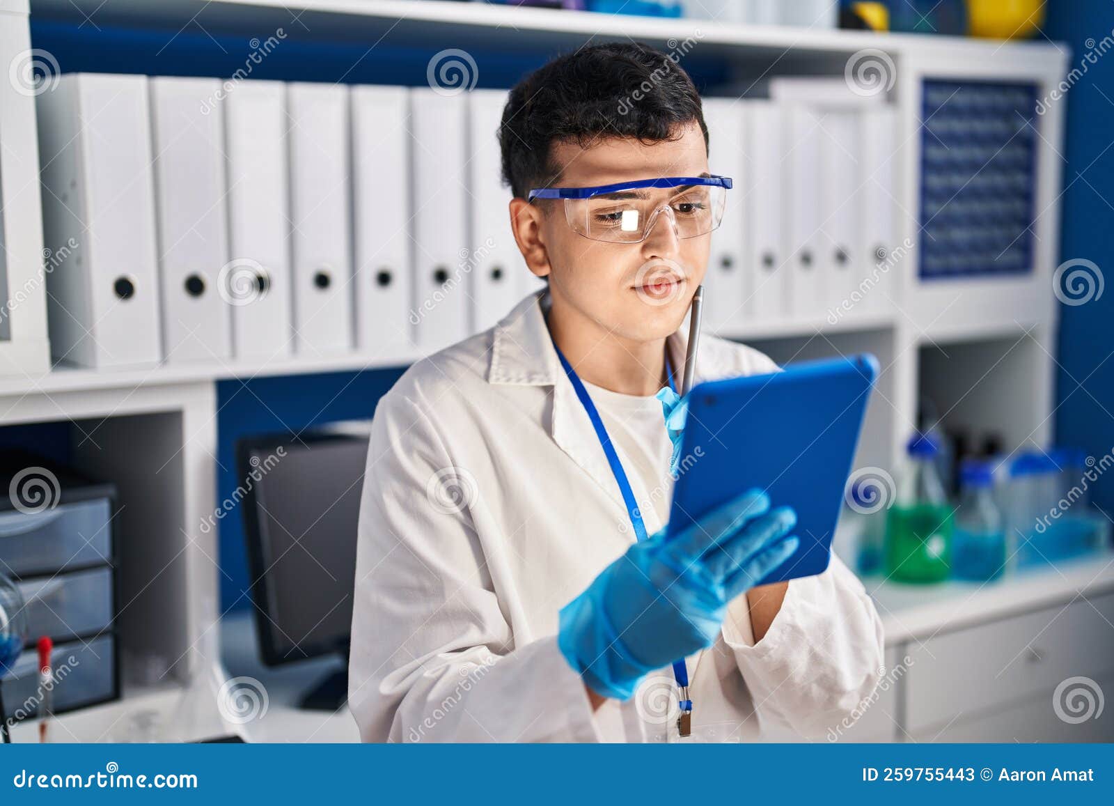 Young Non Binary Man Scientist Using Touchpad at Laboratory Stock Image ...