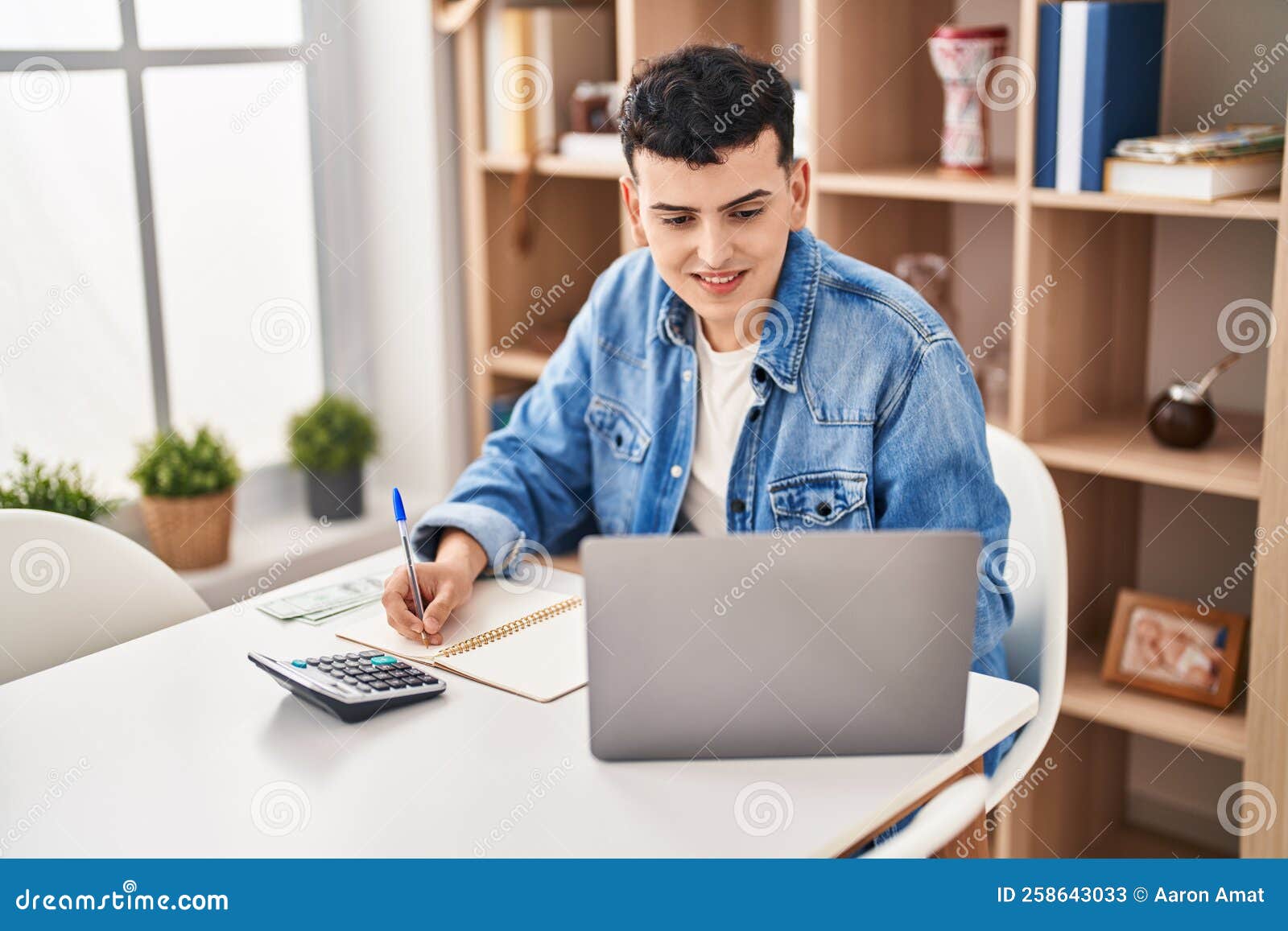 Young Non Binary Man Sitting on Table Doing the Accounting at Home ...
