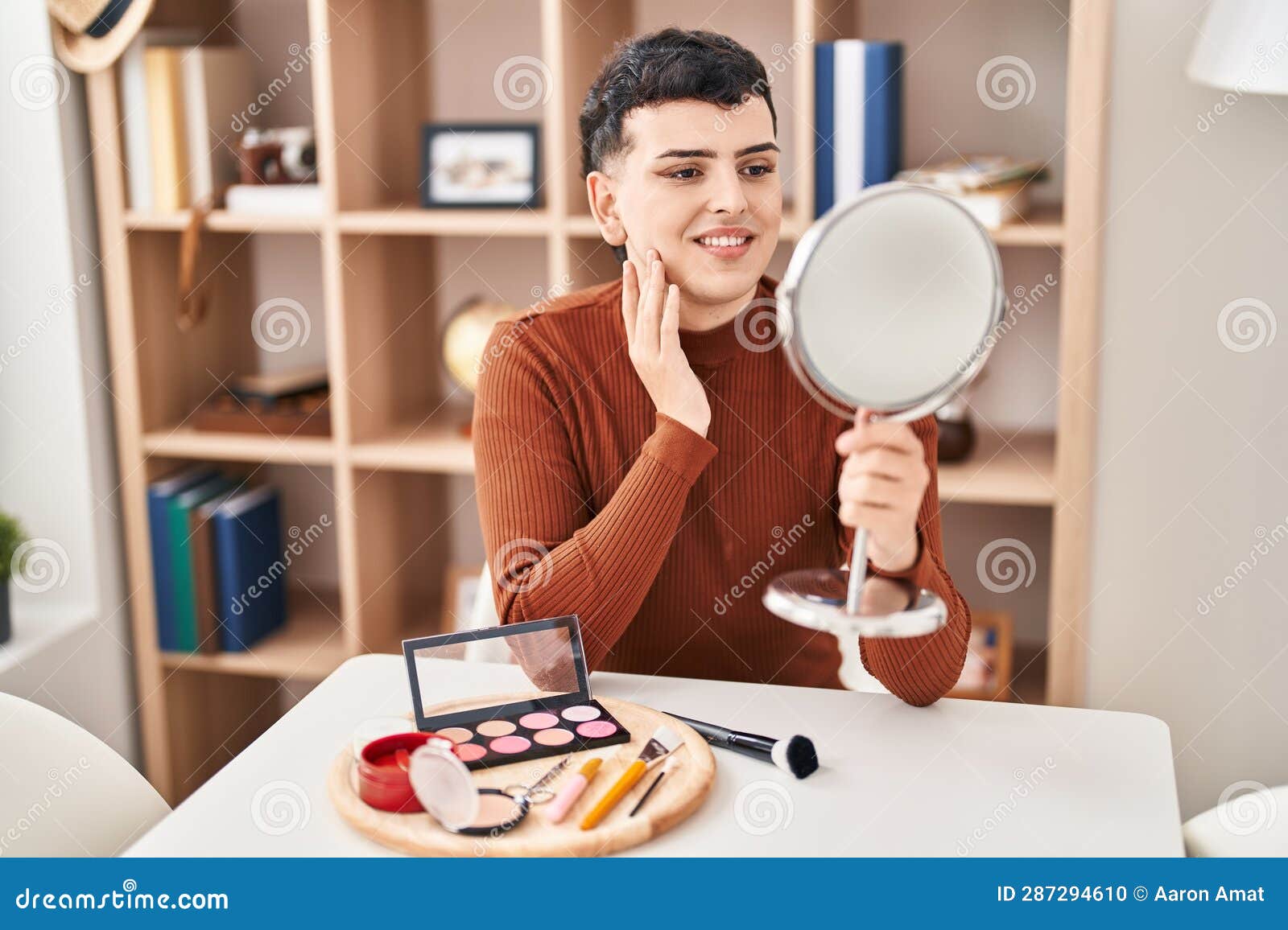 Young Non Binary Man Smiling Confident Looking on Mirror at Home Stock ...