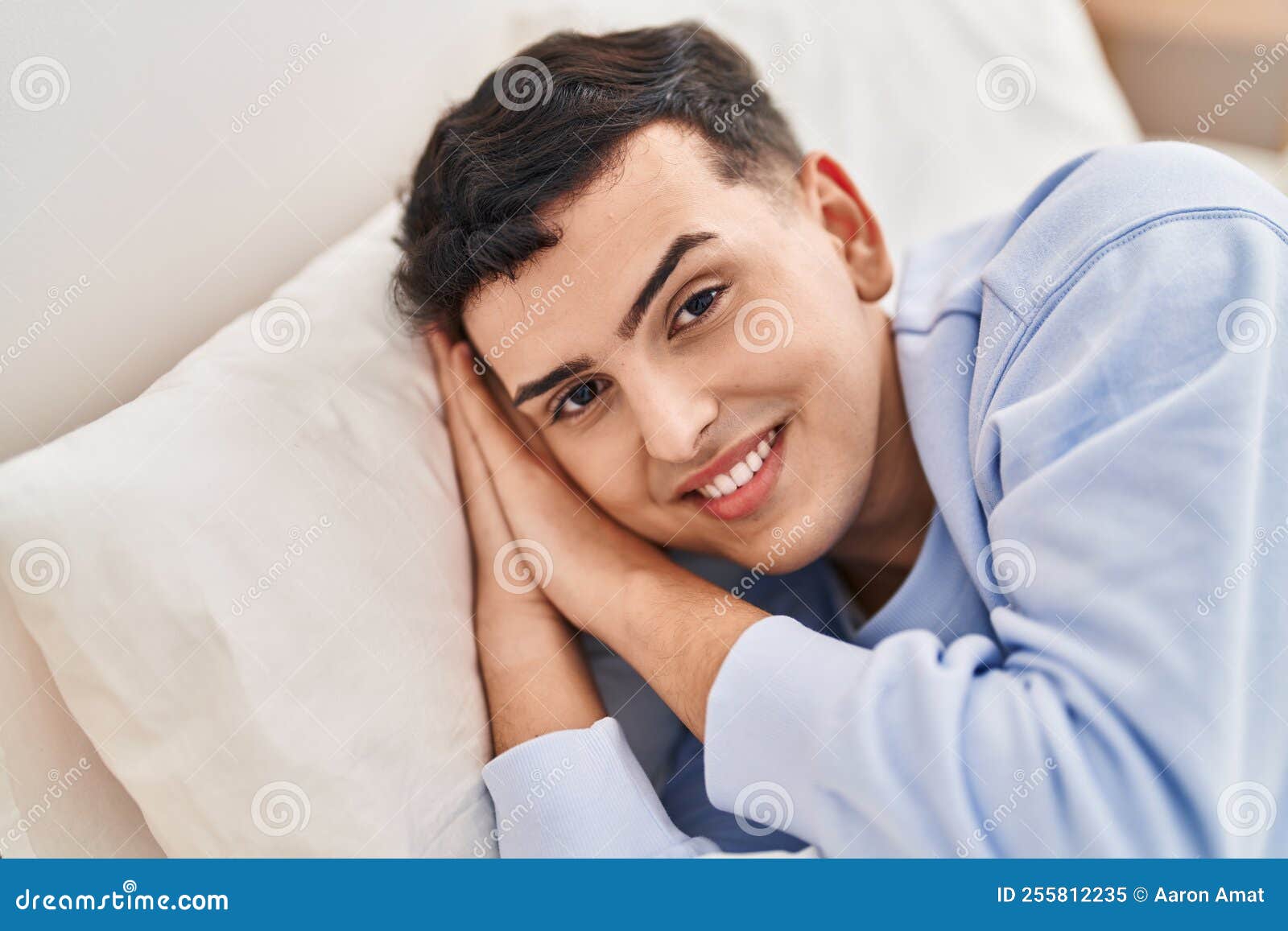 Young Non Binary Man Smiling Confident Lying on Bed Stock Image - Image ...