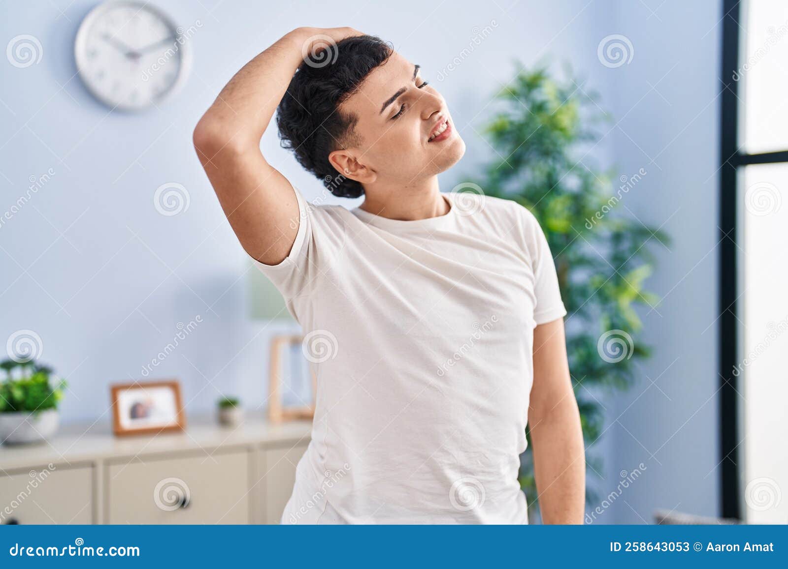 Young Non Binary Man Smiling Confident Stretching Head at Home Stock ...