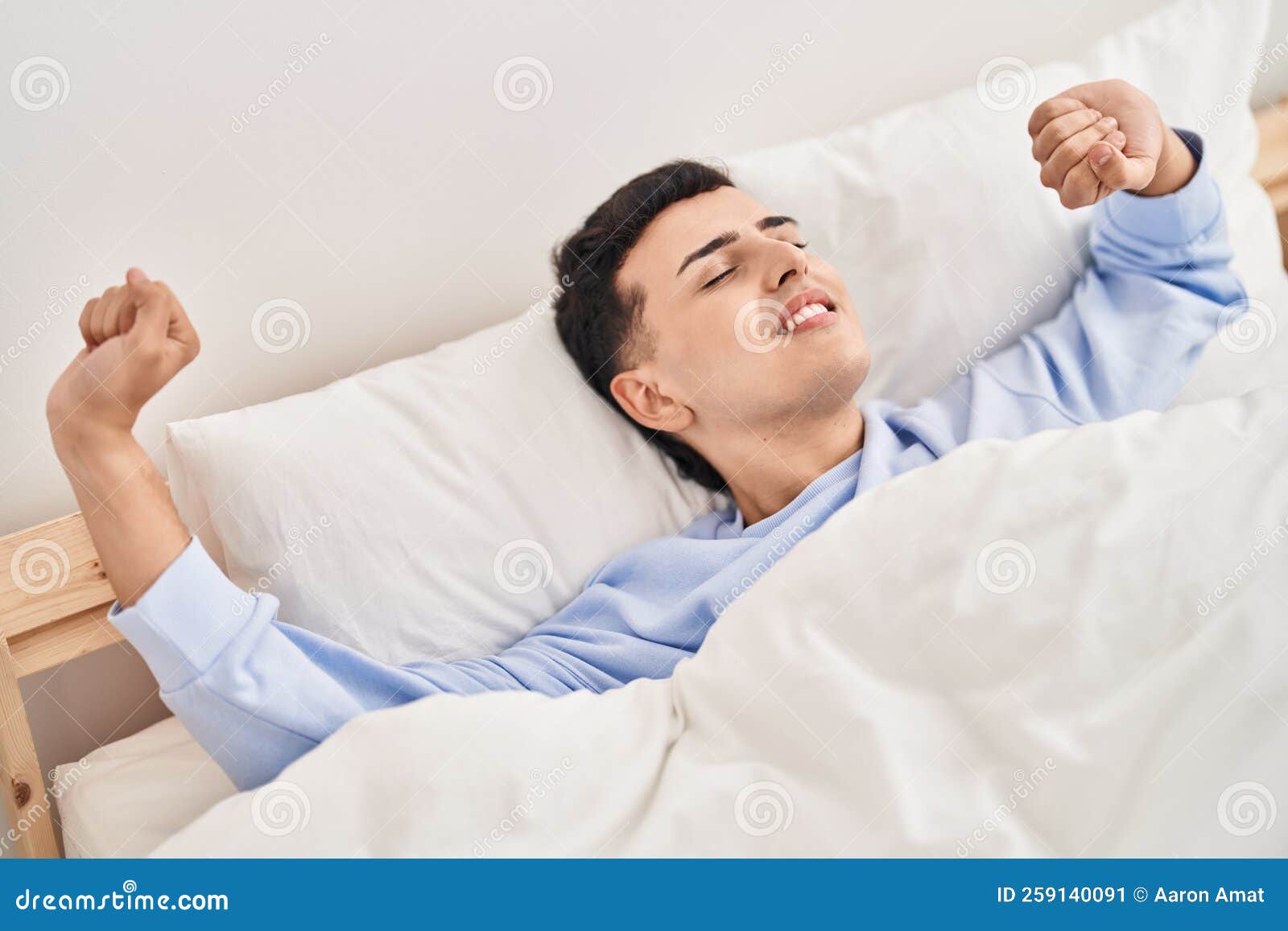 Young Non Binary Man Waking Up Stretching Arms Stock Image - Image of ...