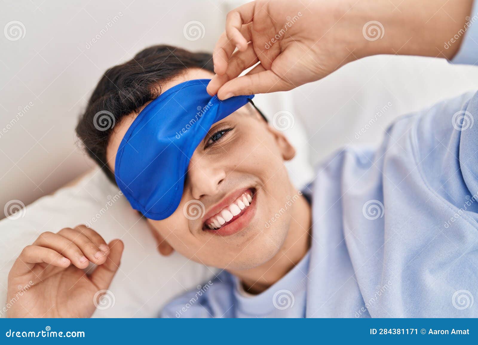 Young Non Binary Man Wearing Sleep Mask Lying on Bed Stock Image ...