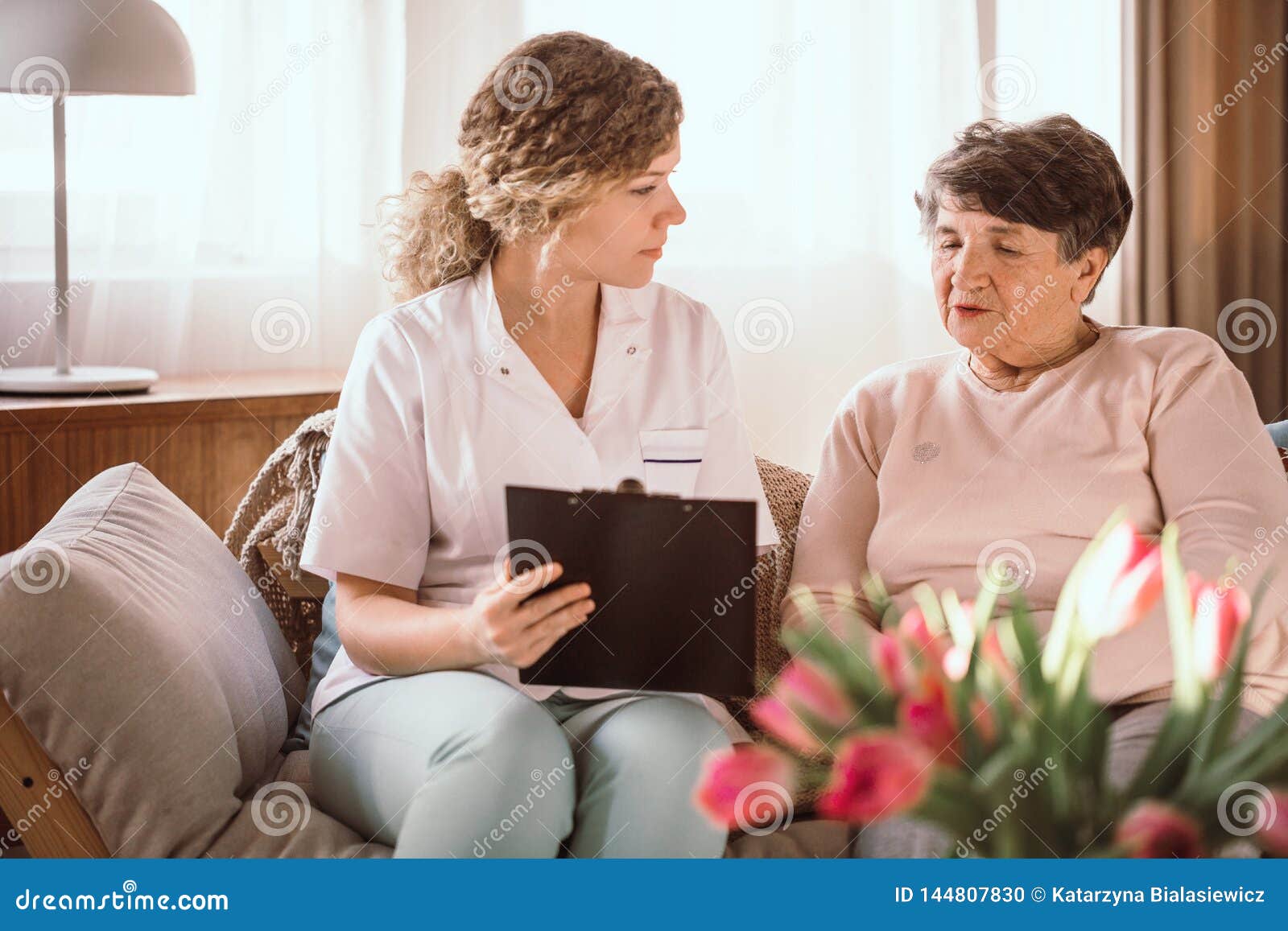 Nurse Helping Elderly Lady with Filling in the Forms in the Nursing ...