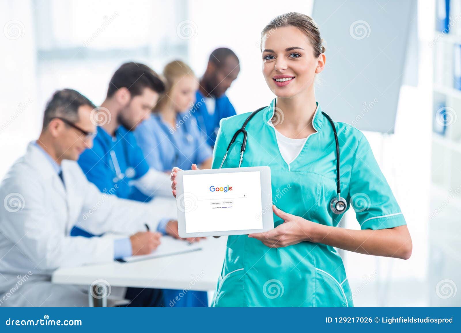 Young nurse holding tablet editorial photo. Image of hospital - 129217026