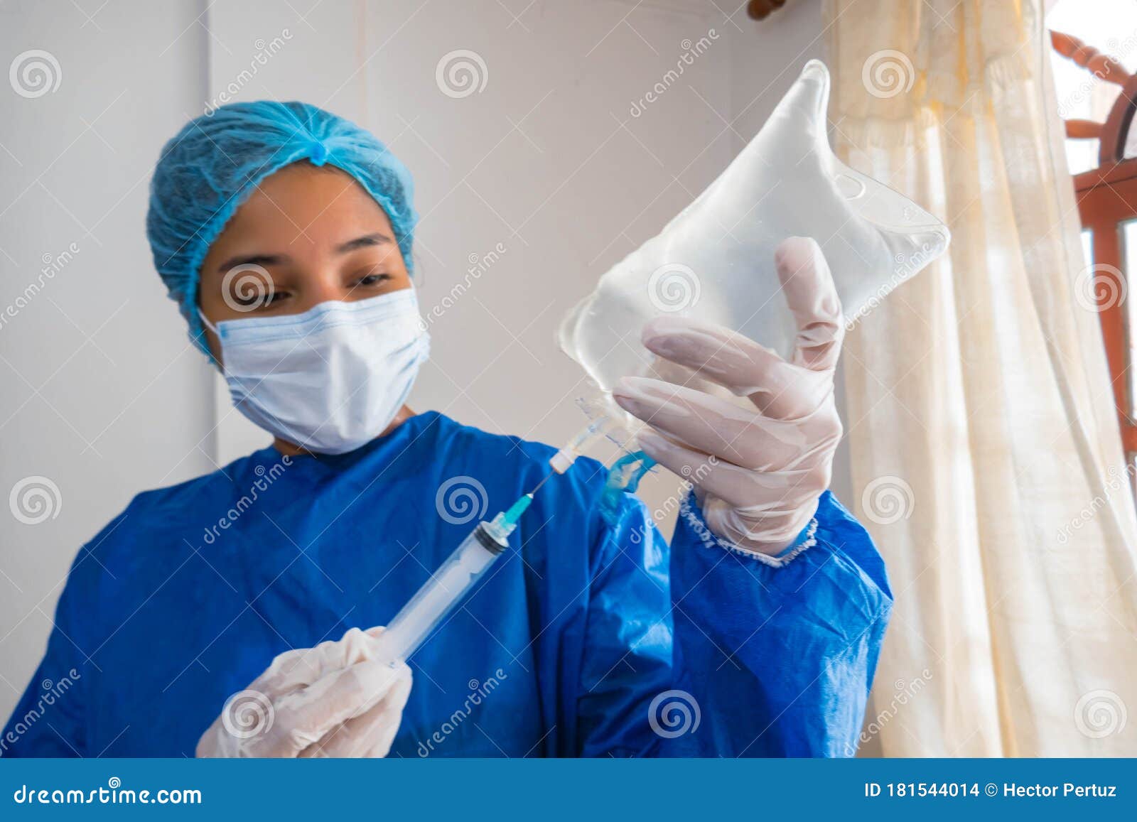 Young Nurse with Mask and Hands in Gloves Preparing Saline Solution ...