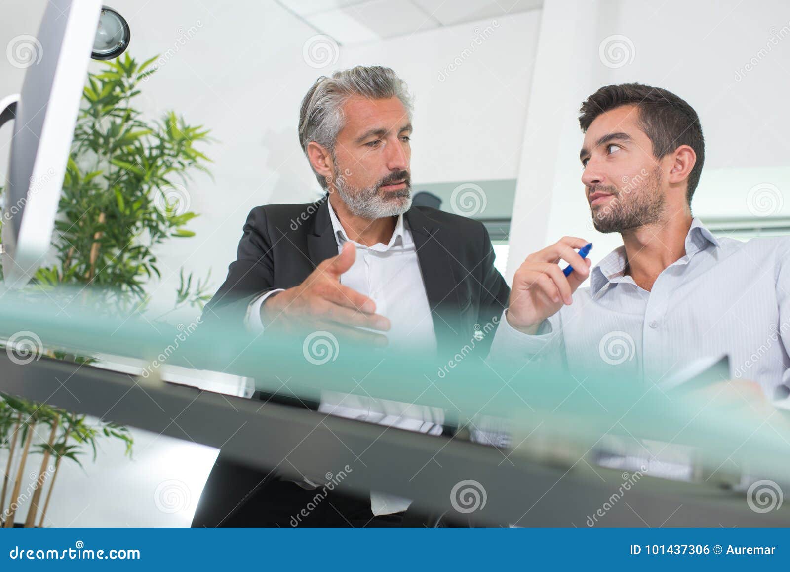 Young Office Professional Having Conversation with Boss Stock Photo ...