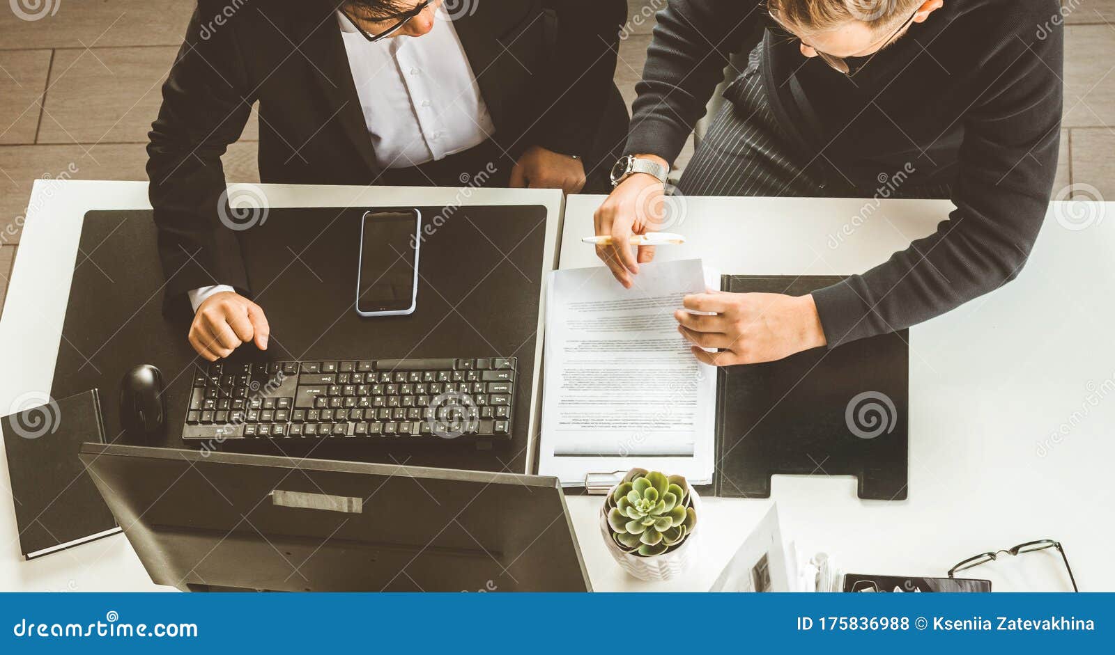 Young Office Worker Sitting at Desk, Using Computer. Two Business Man ...