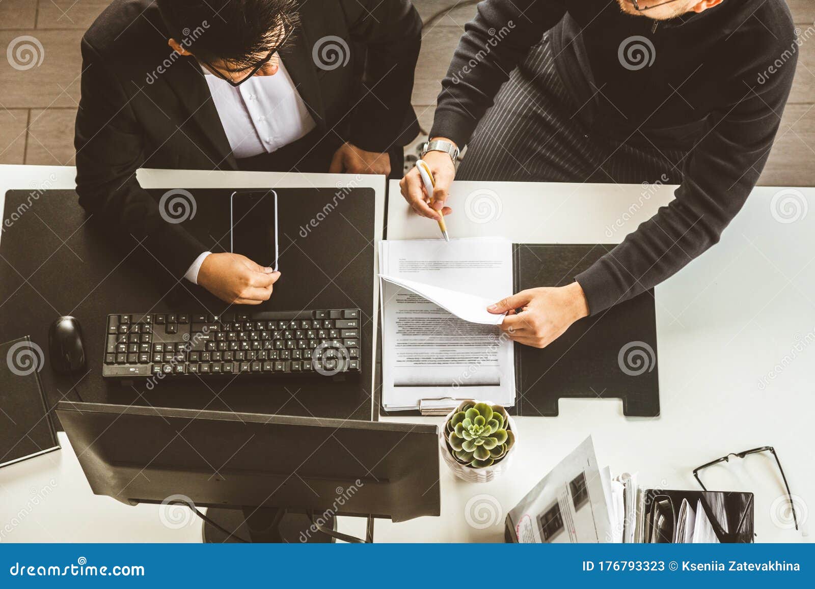 Young Office Worker Sitting at Desk, Using Computer. Two Business Man ...