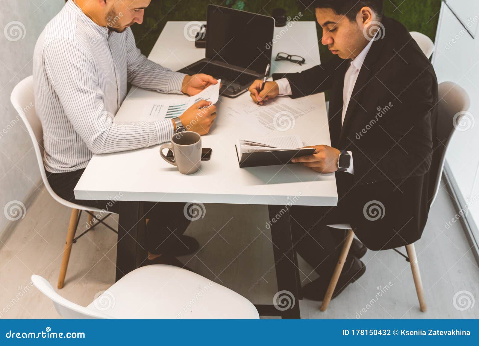Young Office Worker Sitting at Desk, Using Computer. Two Business Man ...
