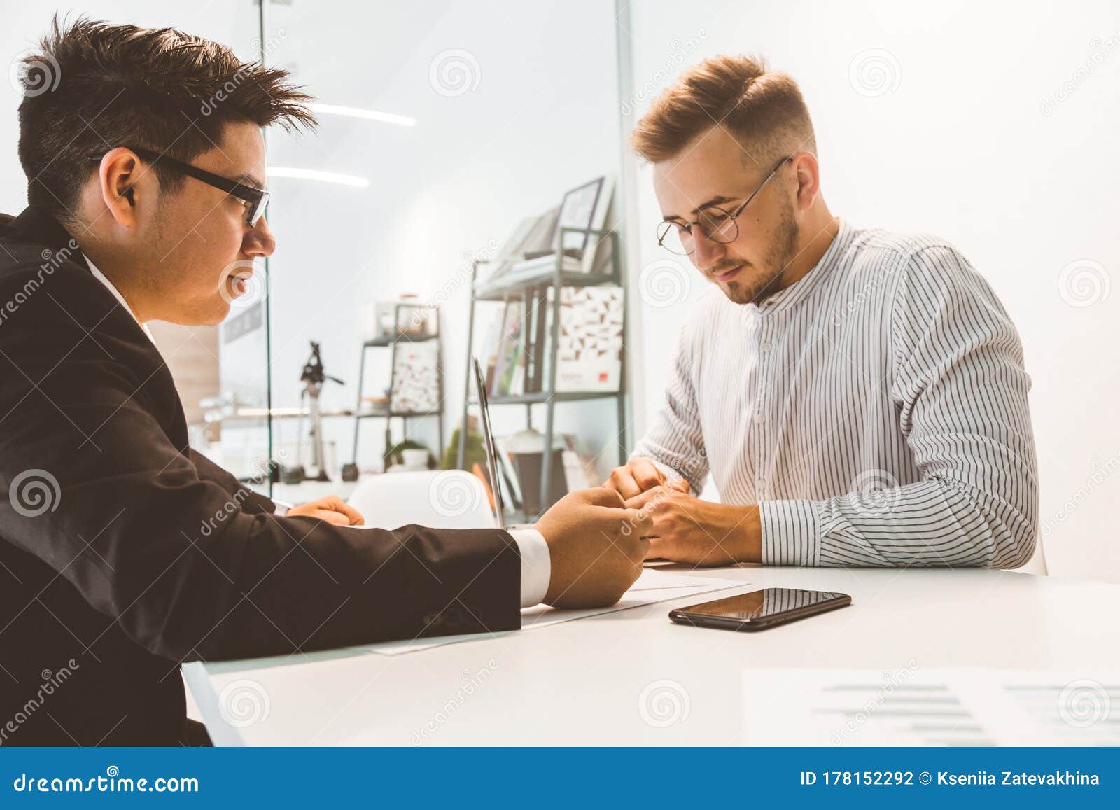 Young Office Worker Sitting at Desk, Using Computer. Two Business Man ...