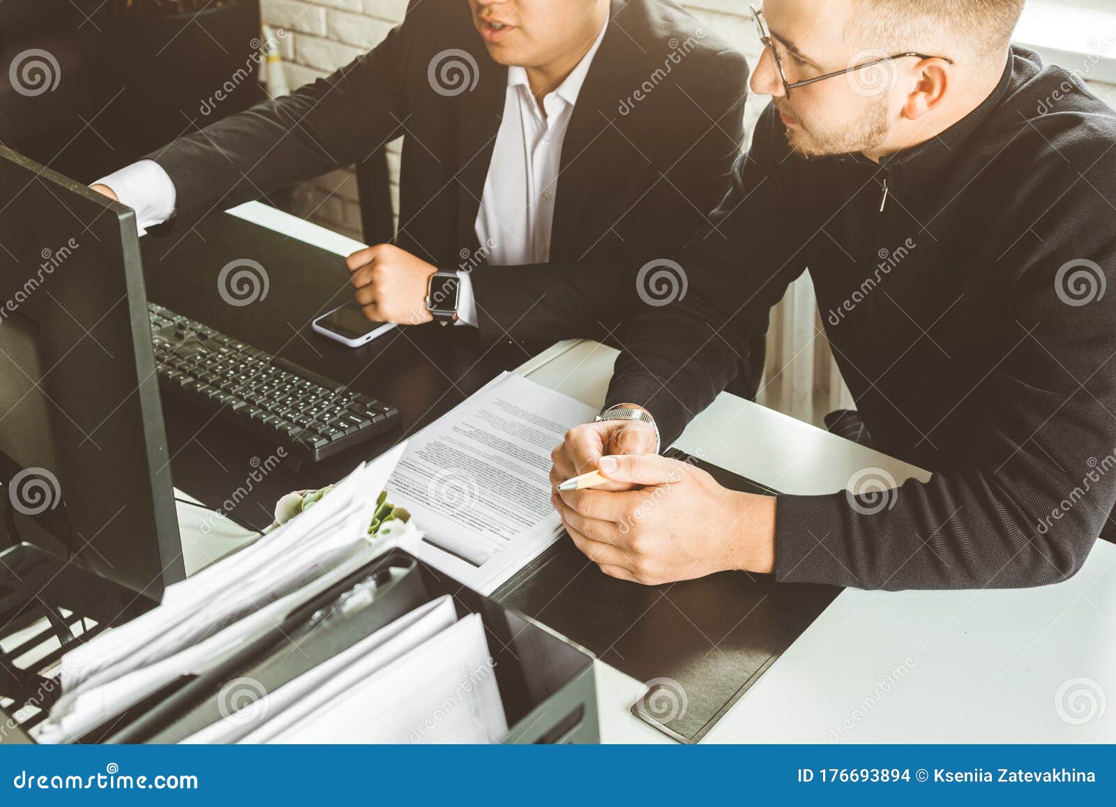 Young Office Worker Sitting at Desk, Using Computer. Two Business Man ...