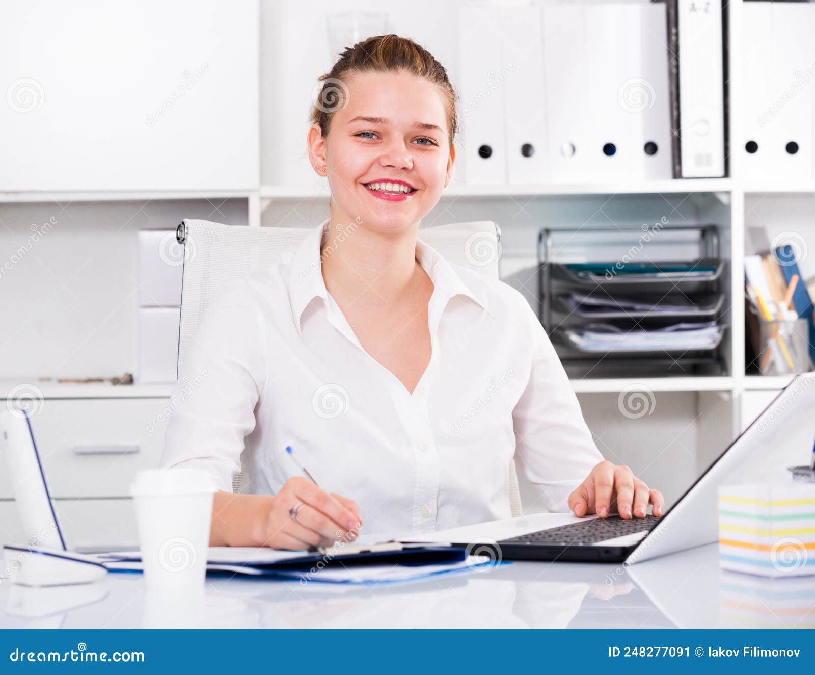 Young Office Worker is Working with Documents and Laptop Stock Image ...