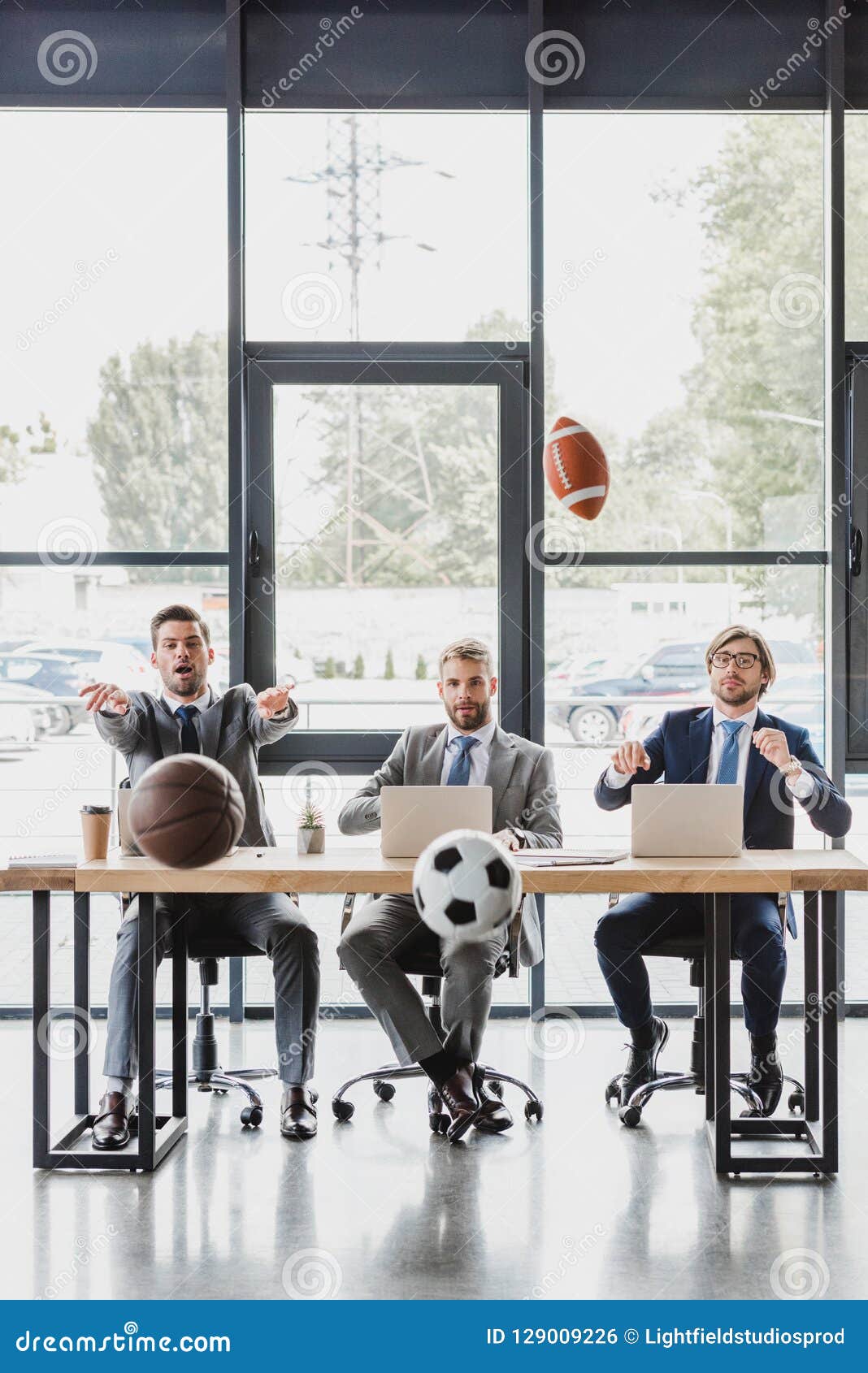 Young Office Workers in Formal Wear Throwing Balls while Working with ...