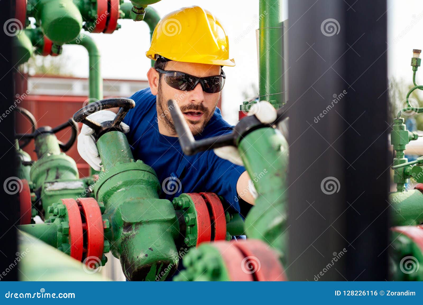 Oil Worker Turning Valve on Oil Rig Stock Photo - Image of industry ...