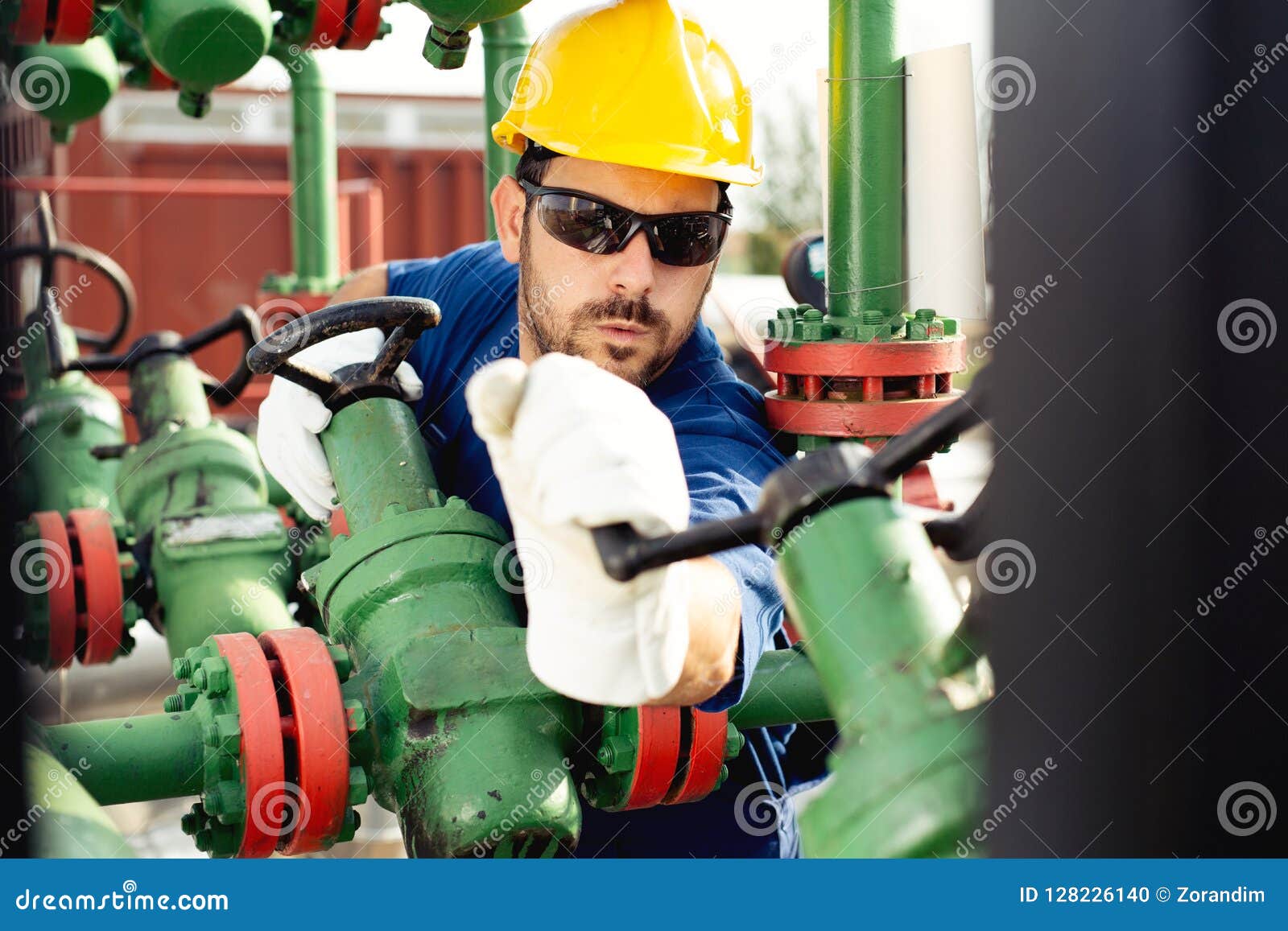 Oil Worker Turning Valve on Oil Rig Stock Photo - Image of mature ...
