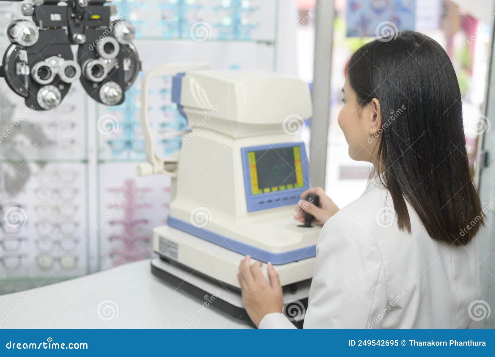 Young Ophthalmologist Doing a Visual Test for Customer Using ...