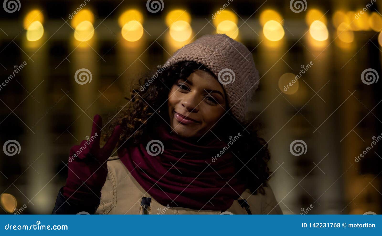 Young Optimistic Model Posing at Camera and Showing Victory Hand Sign ...