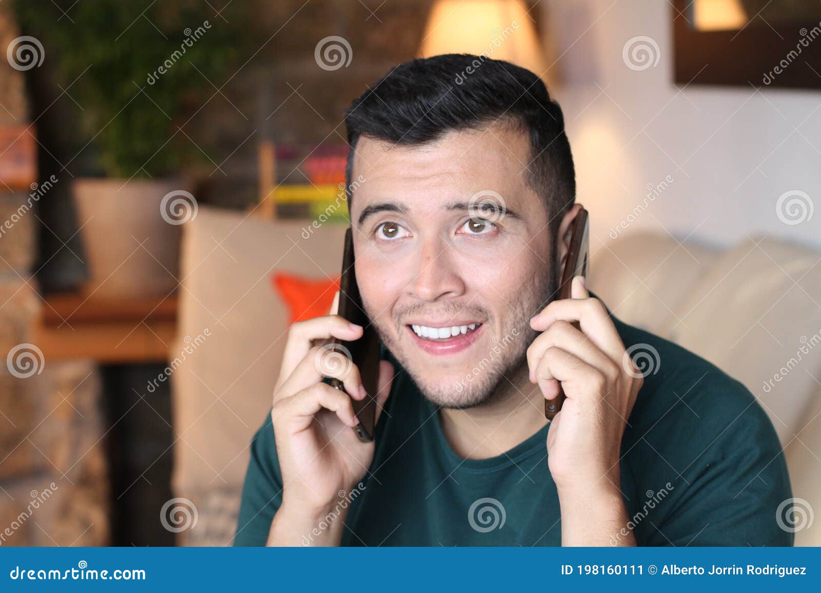 Young Overwhelmed Man Using Two Cellphones Stock Image - Image of angry ...