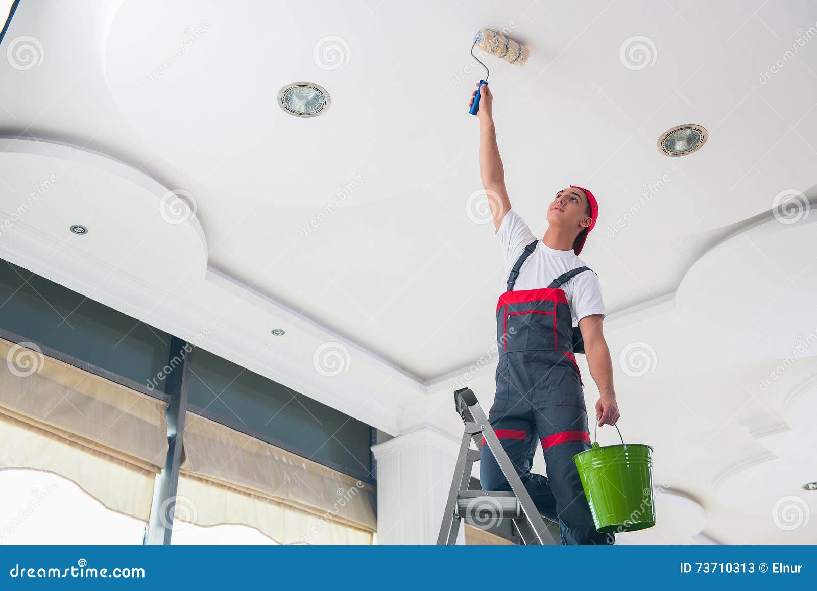 The Young Painter Painting the Ceiling in Construction Concept Stock ...