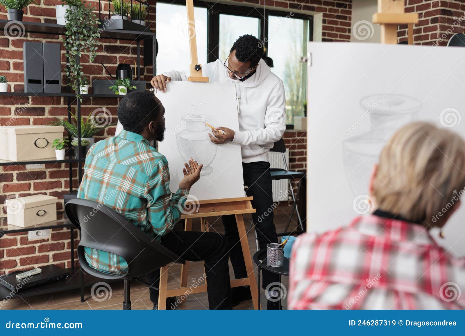 Young Painter Teacher Helping Student with Drawing Process during Art ...