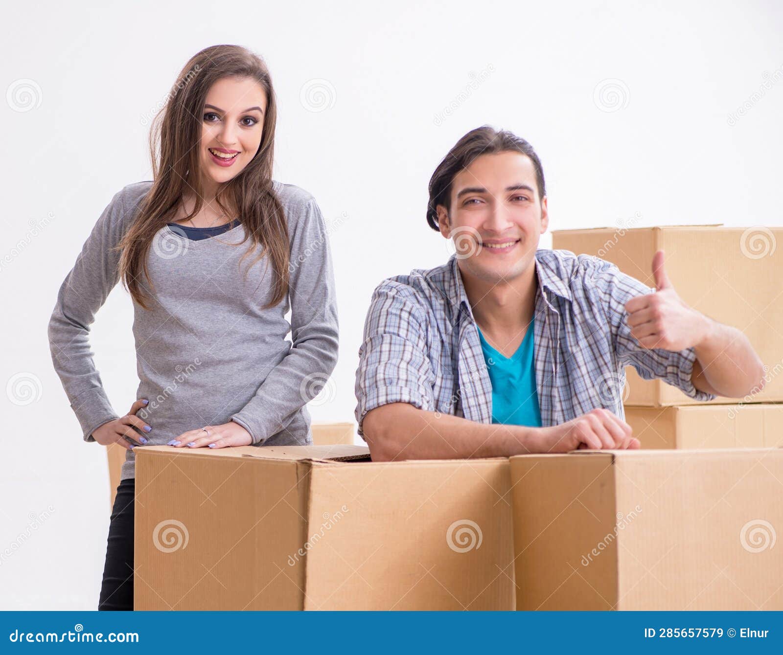 Young Pair Moving To New Flat Stock Image - Image of moving, movers ...