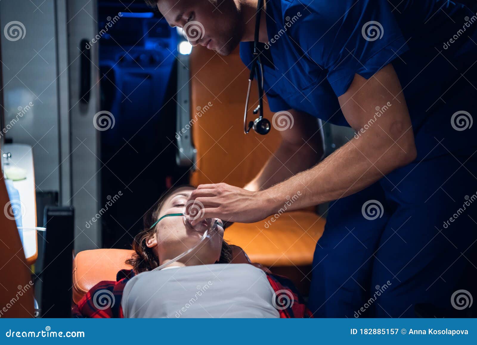 Young Paramedic Giving an Oxygen Mask To His Female Patient in an ... Young Paramedic Giving an Oxygen Mask To His Female Patient in an ...